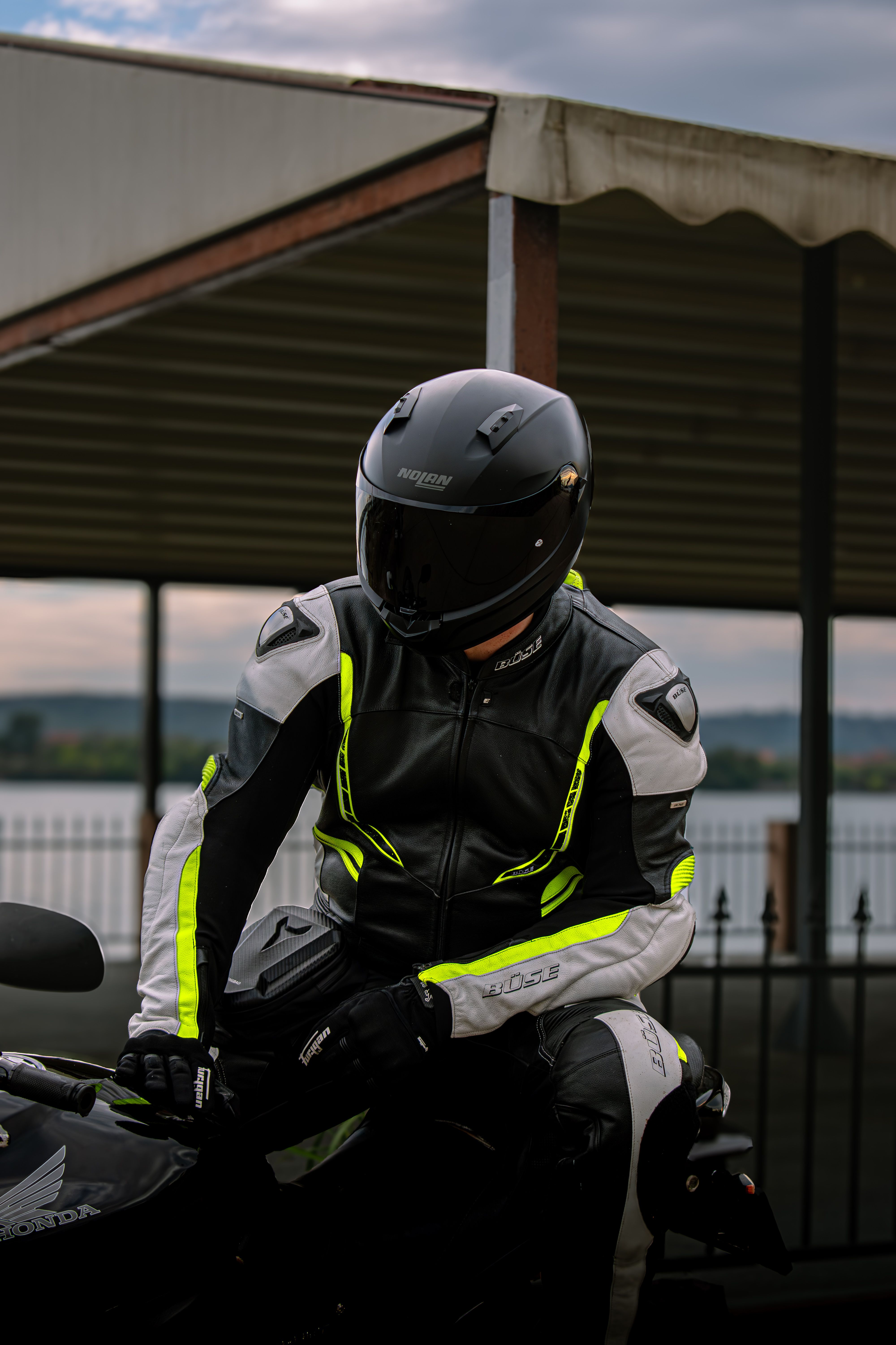 Motorcyclist in Neon Gear at Sunset · Free Stock Photo