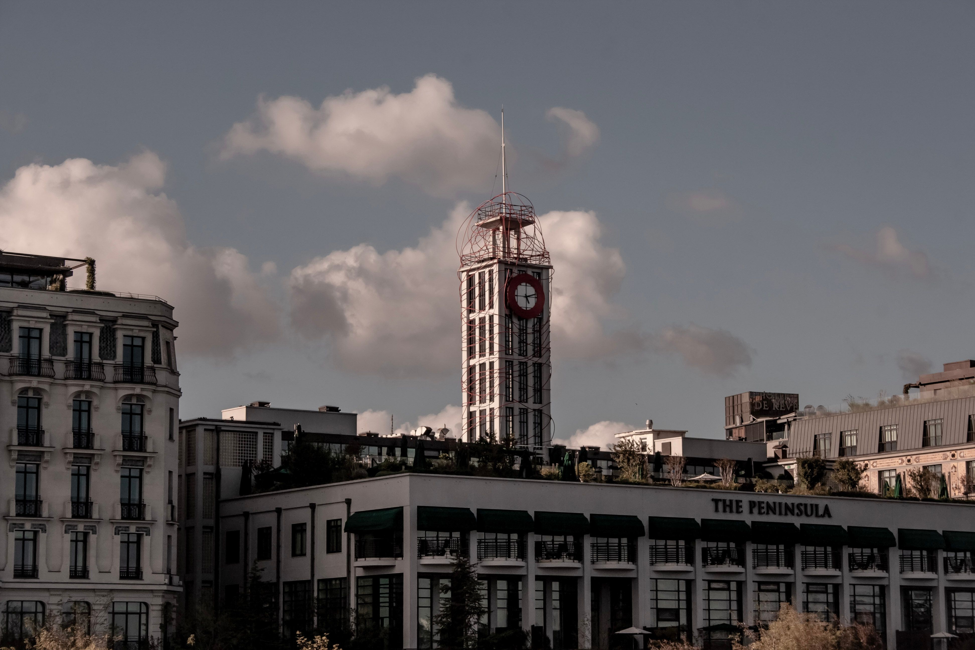 Clock tower over elegant urban architecture · Free Stock Photo