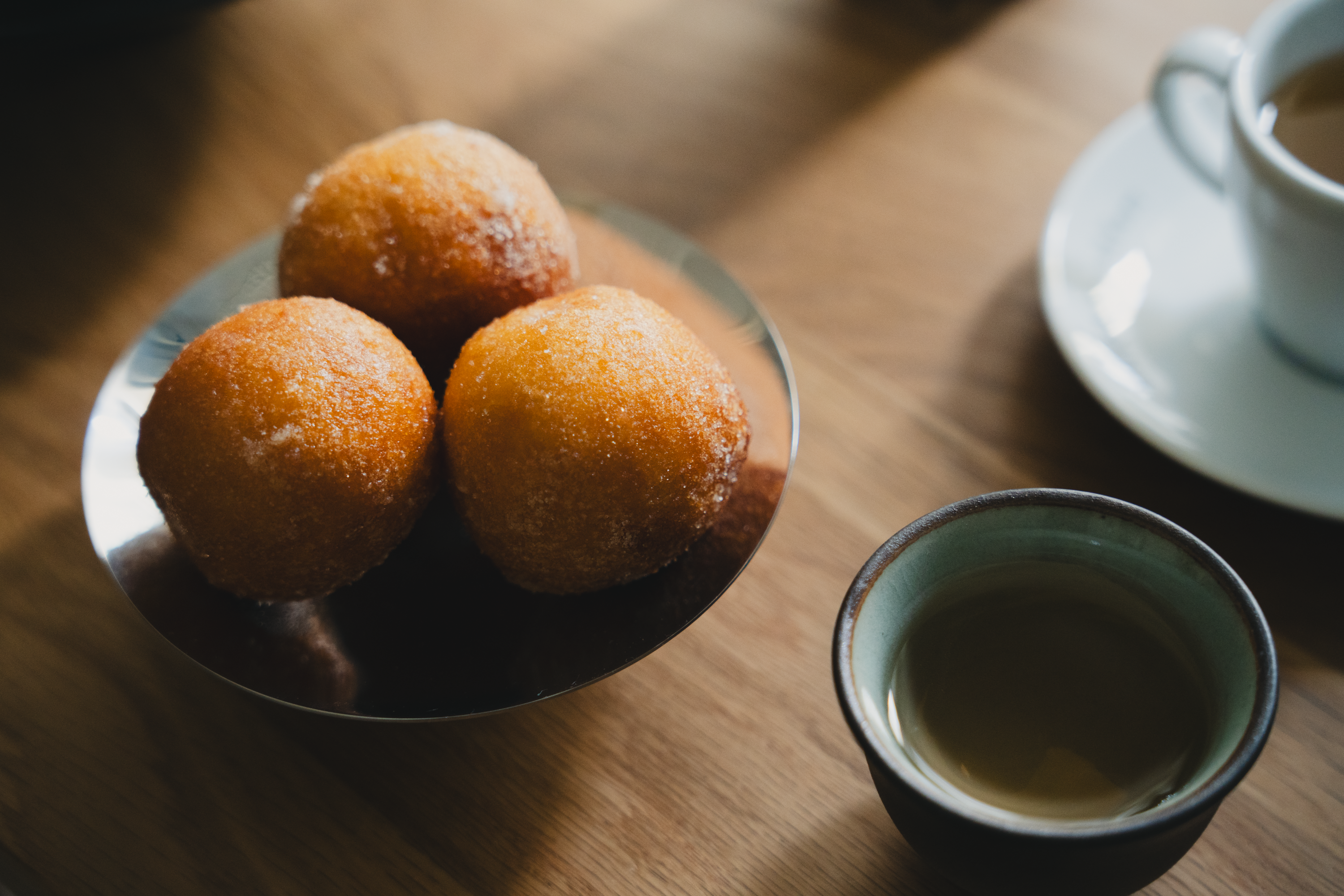 Warm Quarkbällchen with Coffee on a Wooden Table · Free Stock Photo