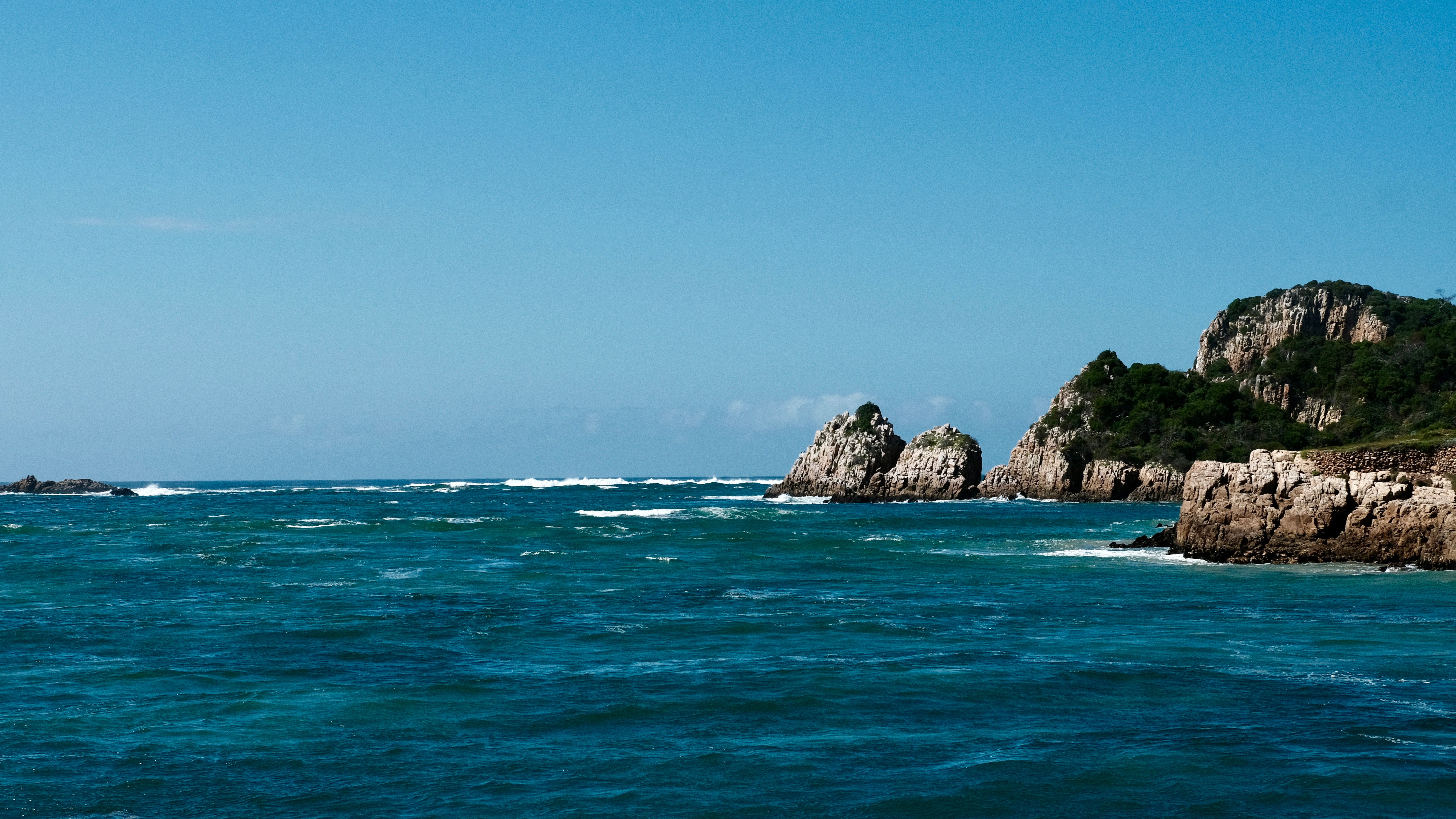 Scenic Ocean View with Rocky Coastline · Free Stock Photo