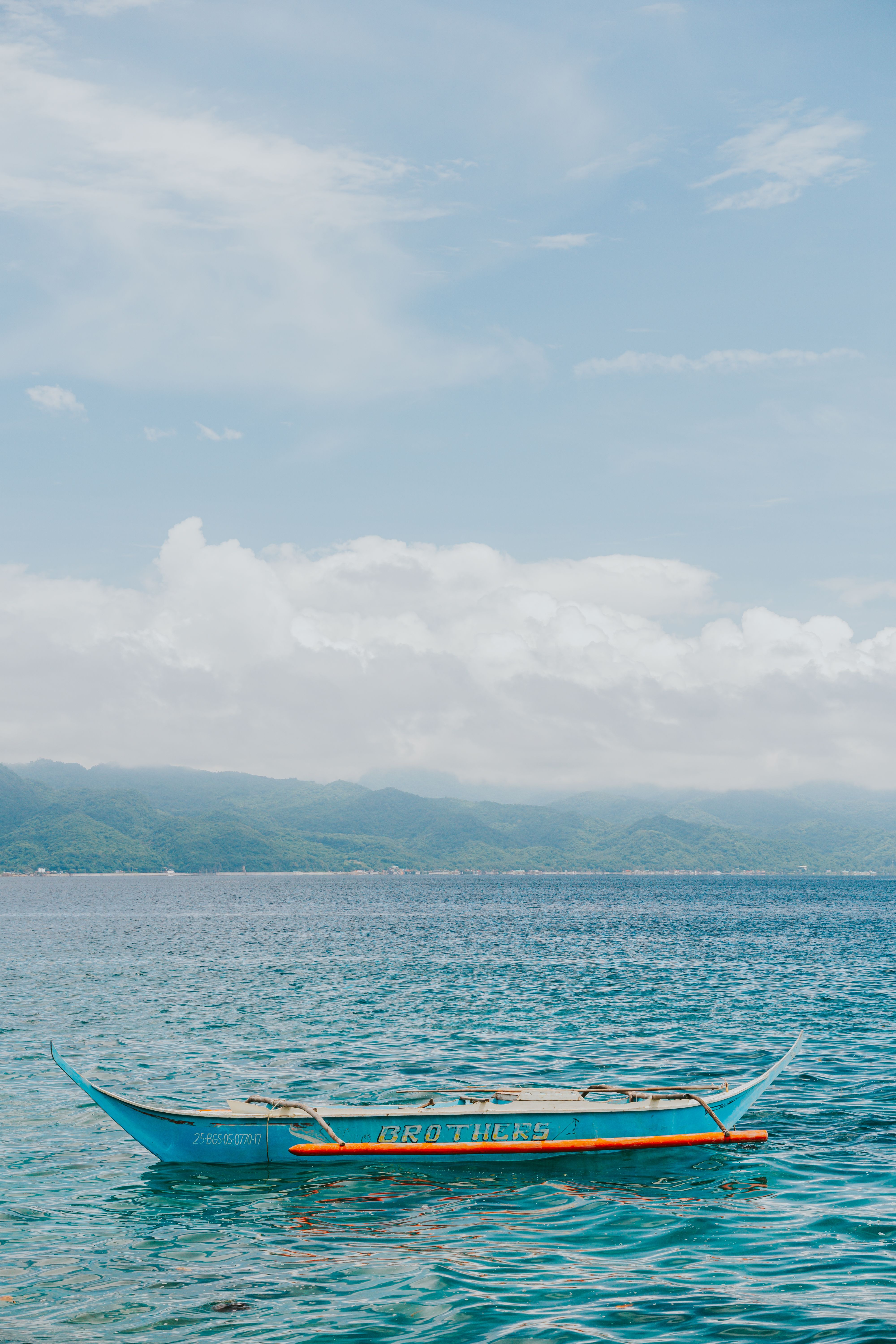 Peaceful Scene of Boat on Clear Sea Under Blue Sky · Free Stock Photo