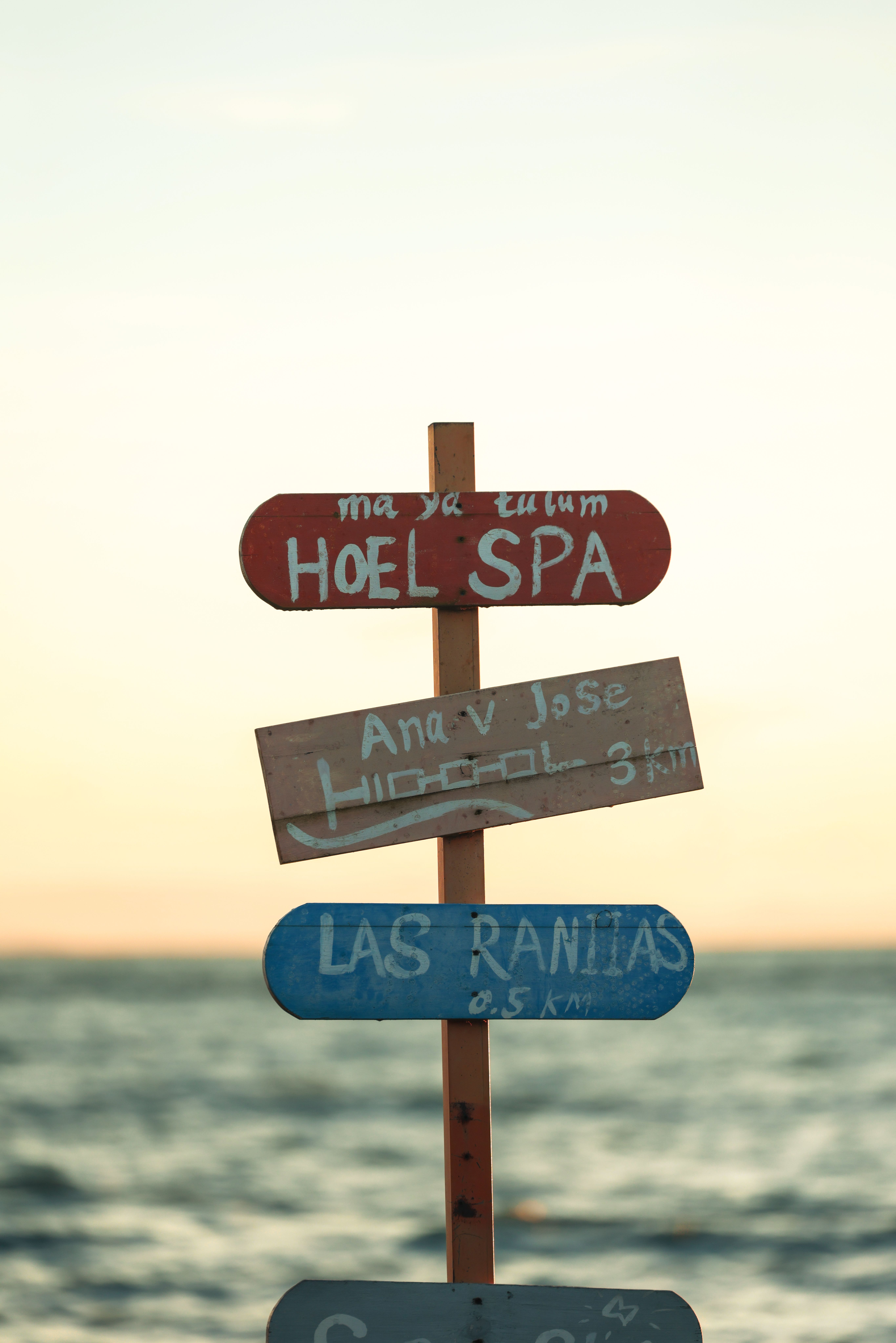 Beachfront directional sign at sunset · Free Stock Photo
