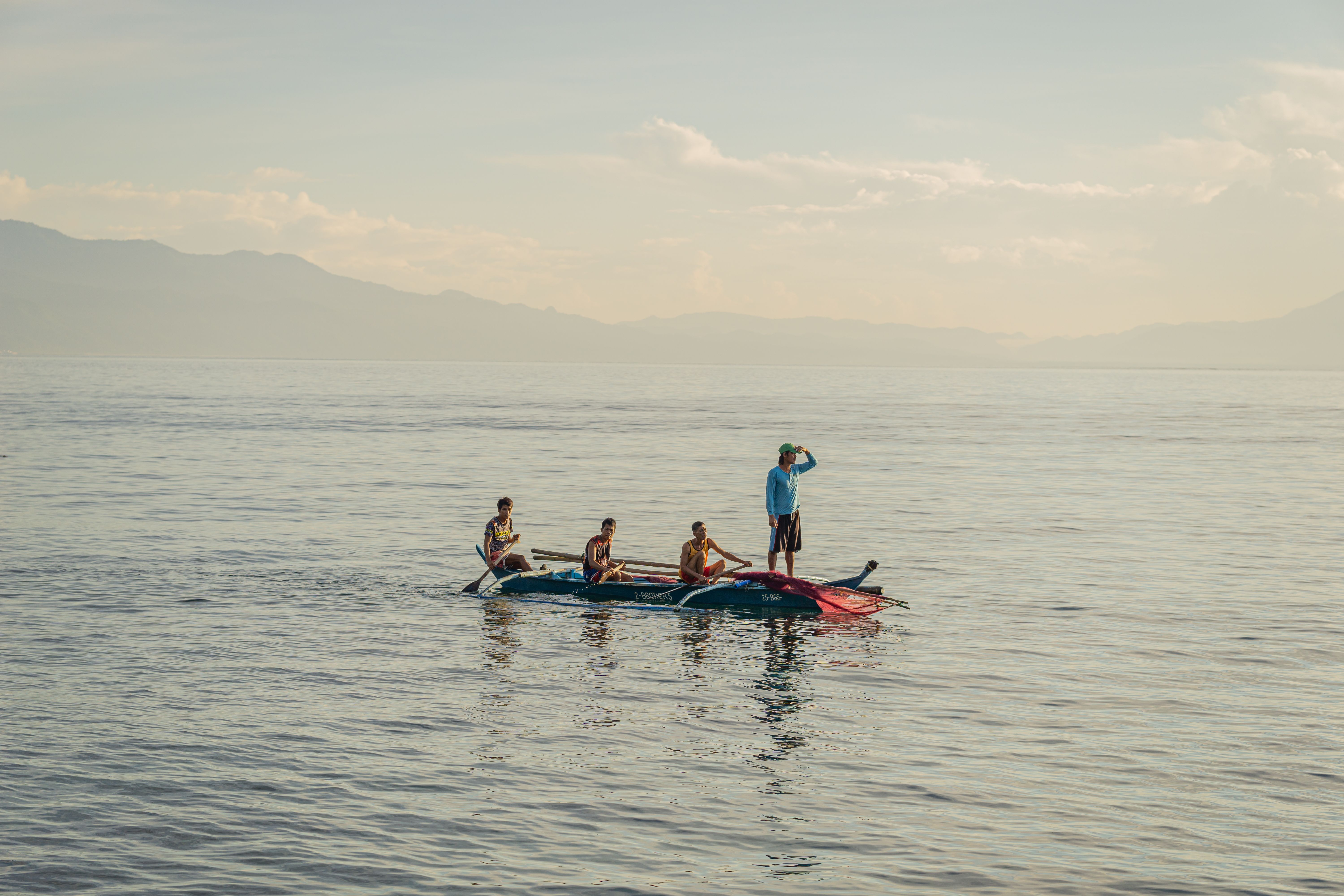 Group of People Kayaking on Serene Ocean Waters · Free Stock Photo