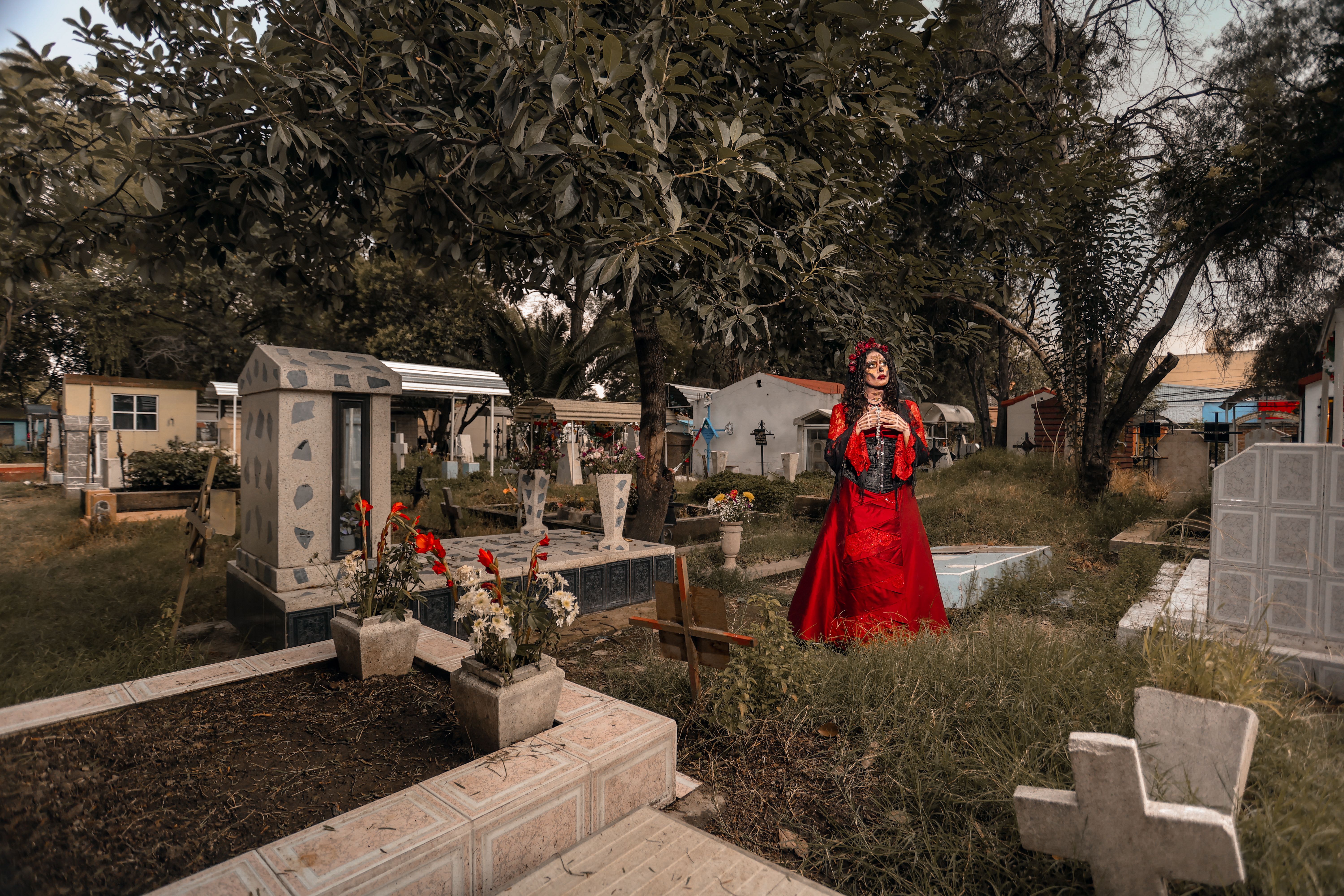 Woman in Red Dress in Mysterious Cemetery Setting · Free Stock Photo