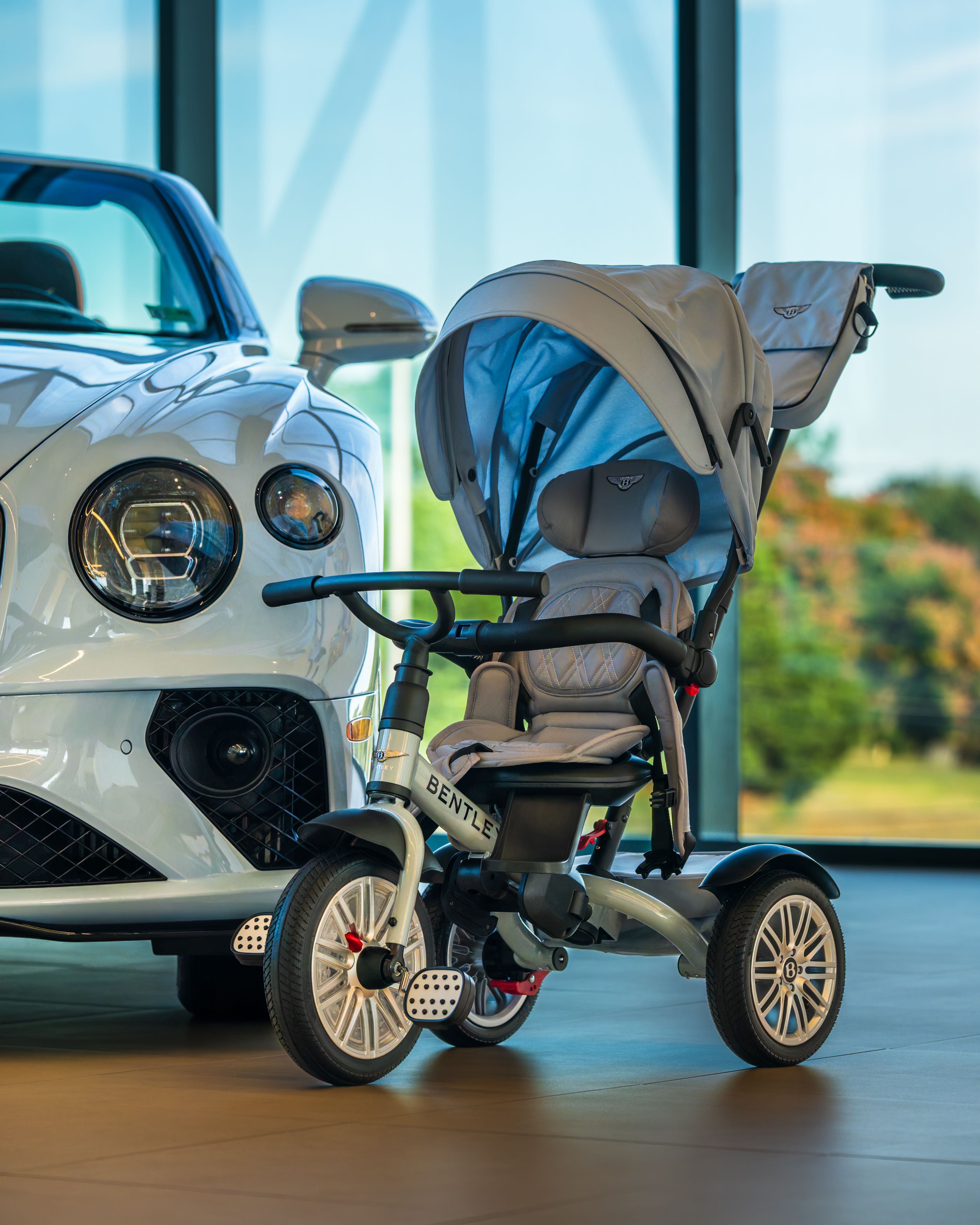 Luxury Car and Baby Stroller in Showroom · Free Stock Photo