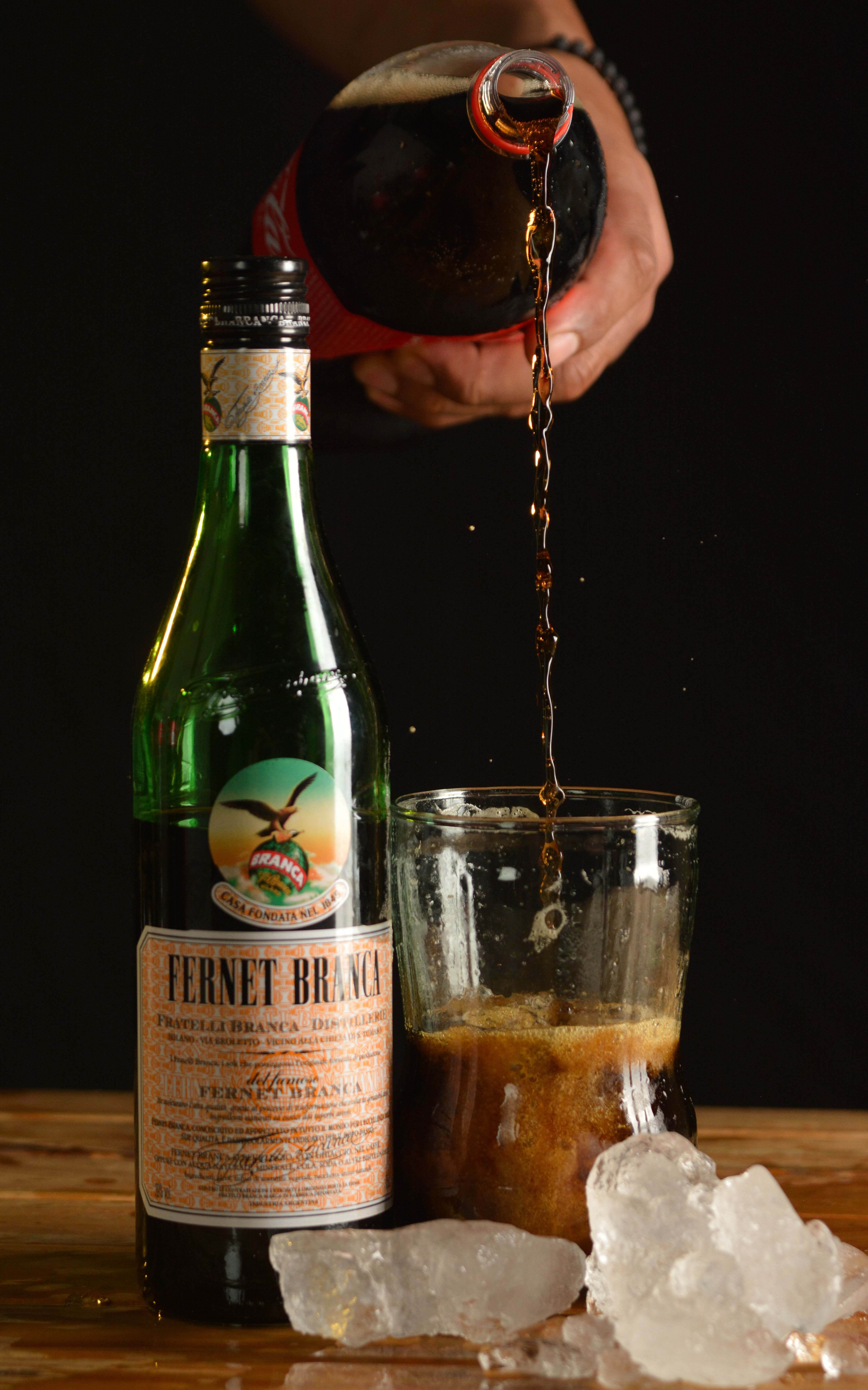 Pouring Classic Fernet Branca with Cola · Free Stock Photo