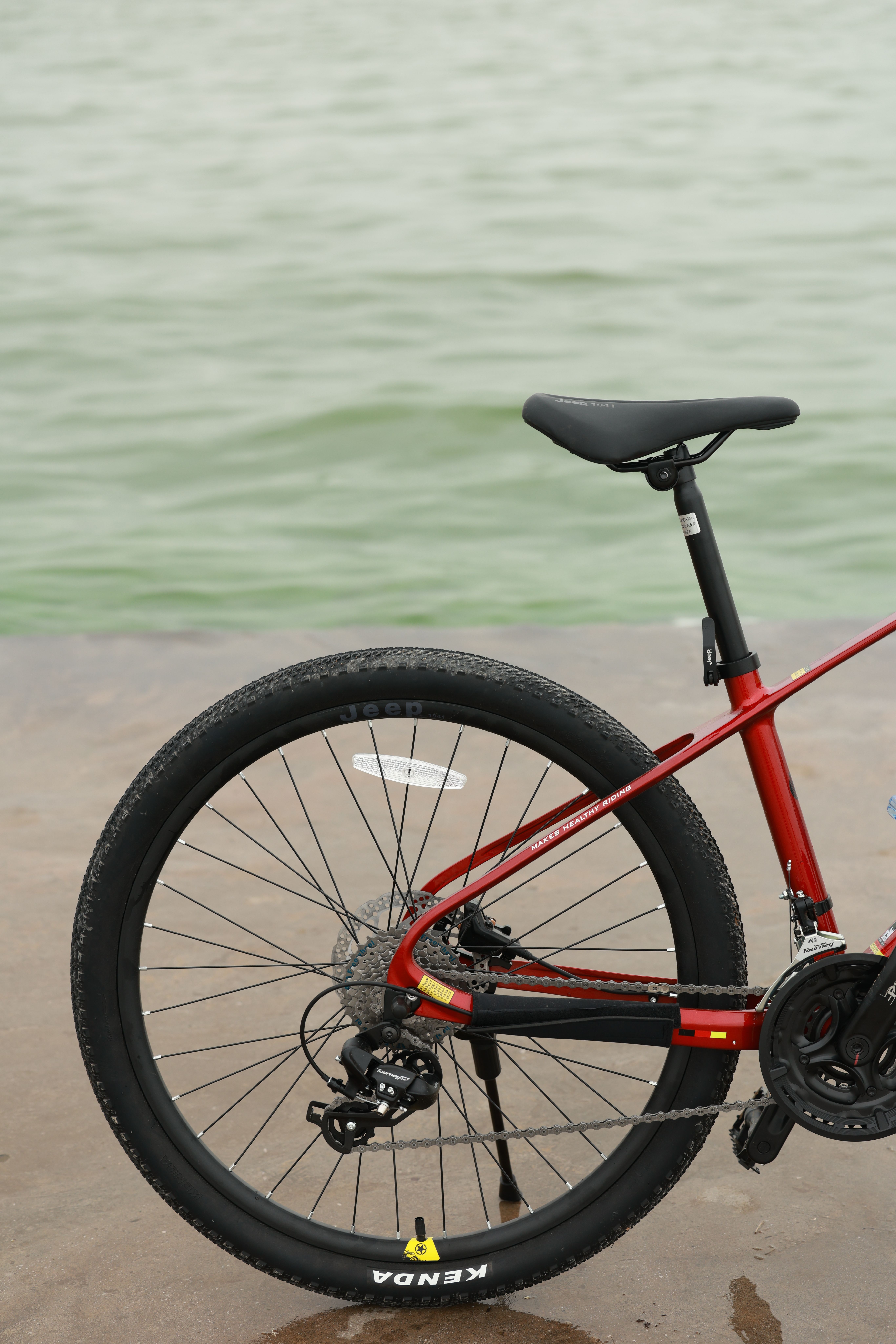 Red Bicycle by the Waterfront on a Cloudy Day · Free Stock Photo