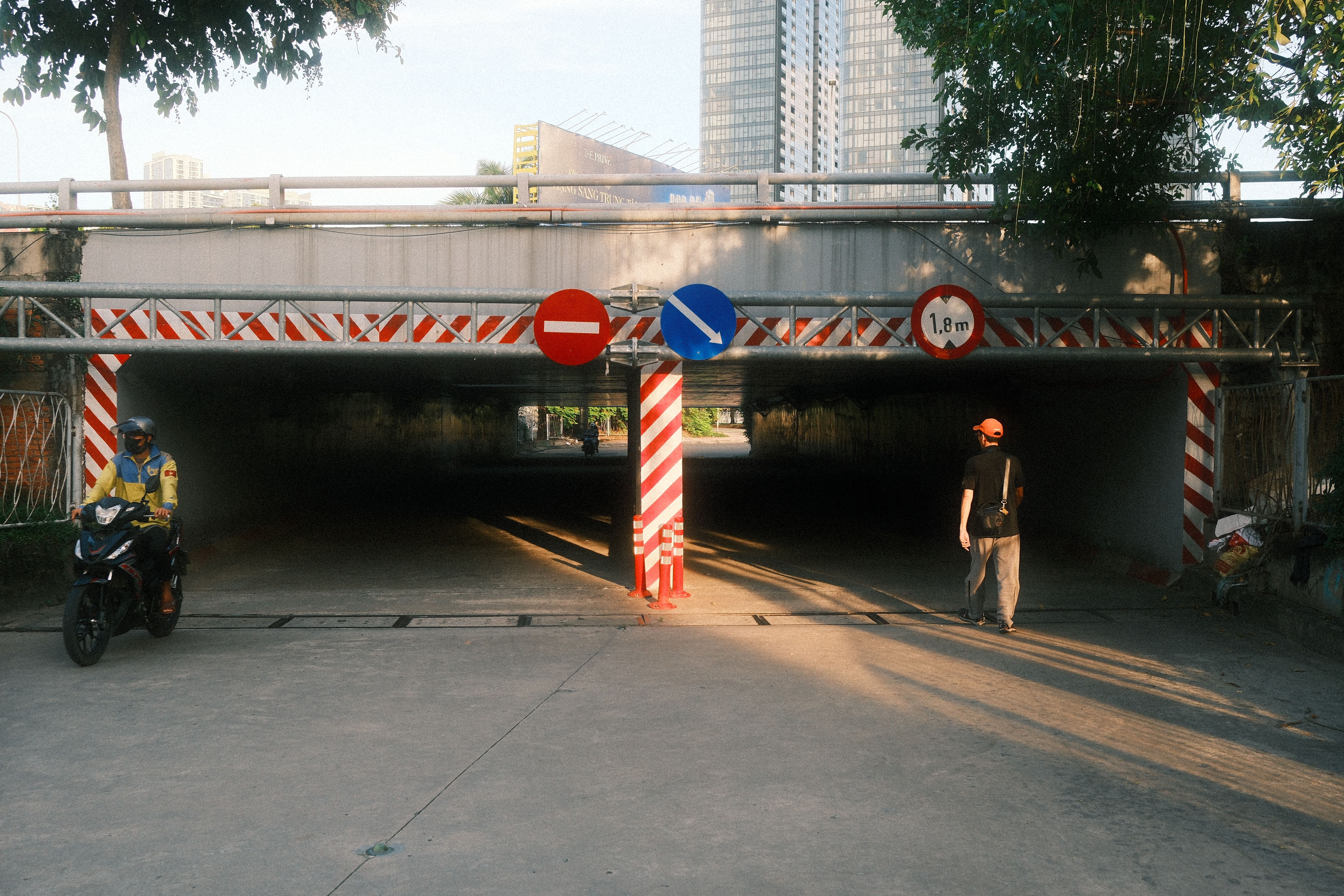 Urban underpass with traffic signs and people · Free Stock Photo