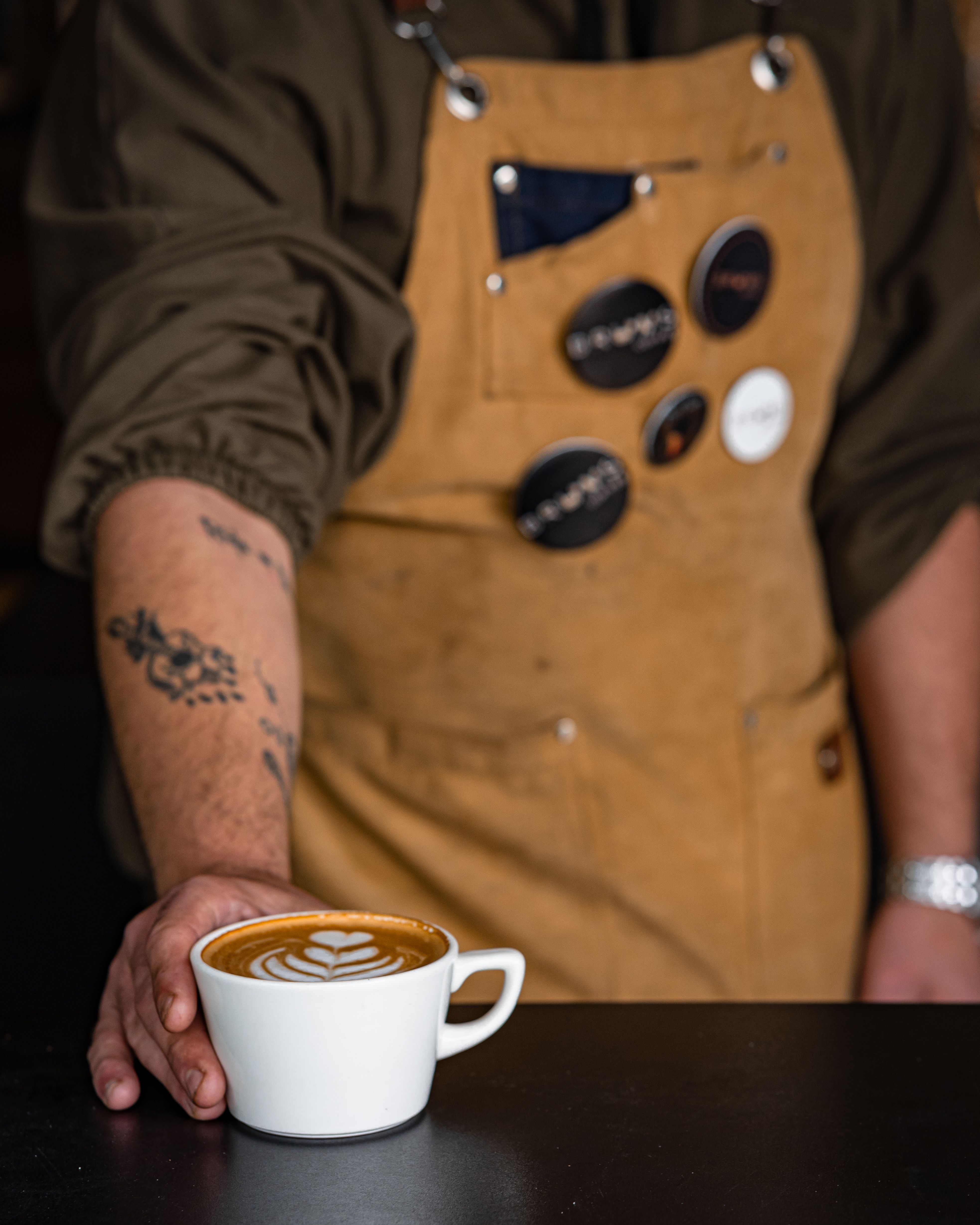Barista with Latte Art in Café Setting · Free Stock Photo