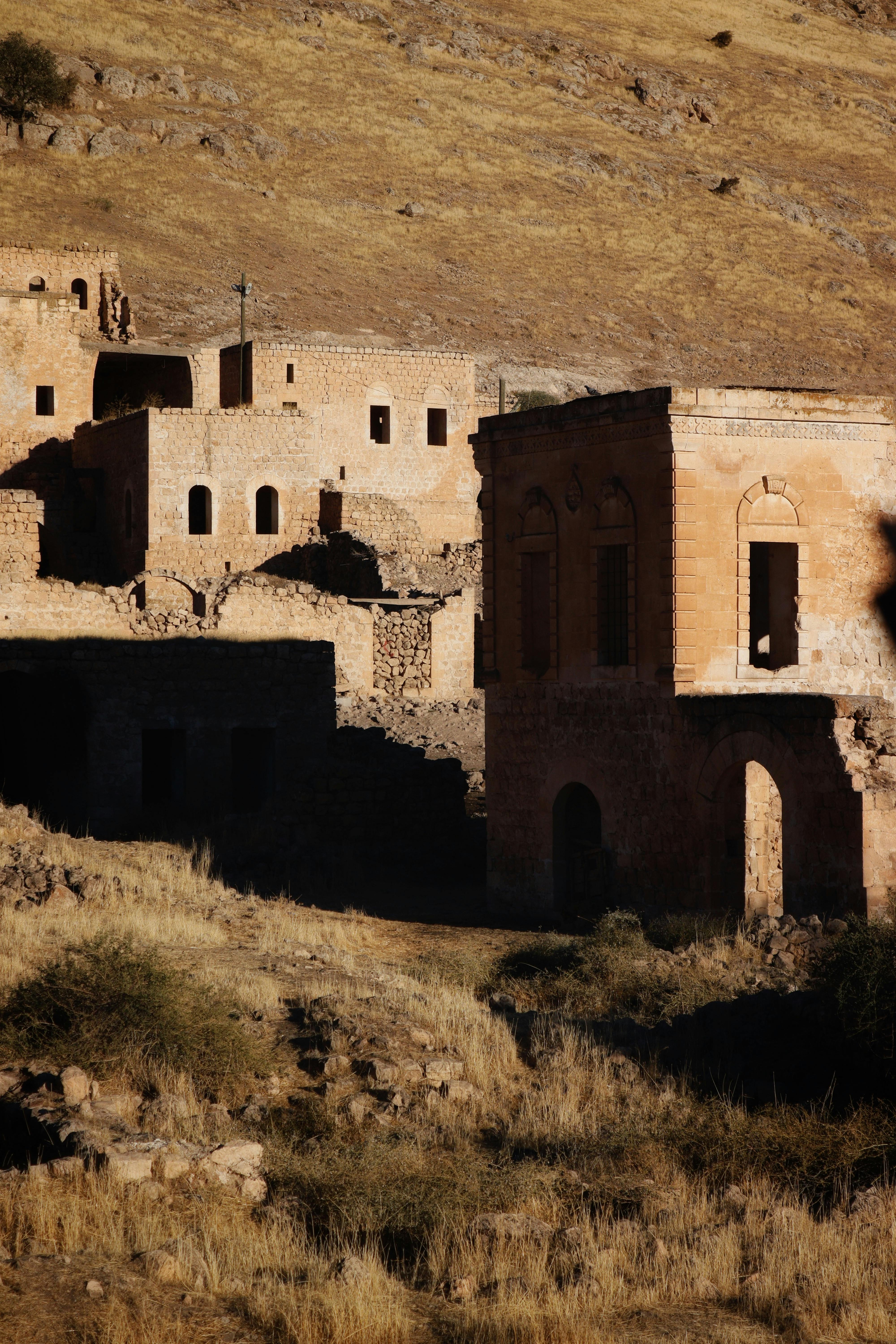 Abandoned Stone Buildings in Sunlit Desert Landscape · Free Stock Photo