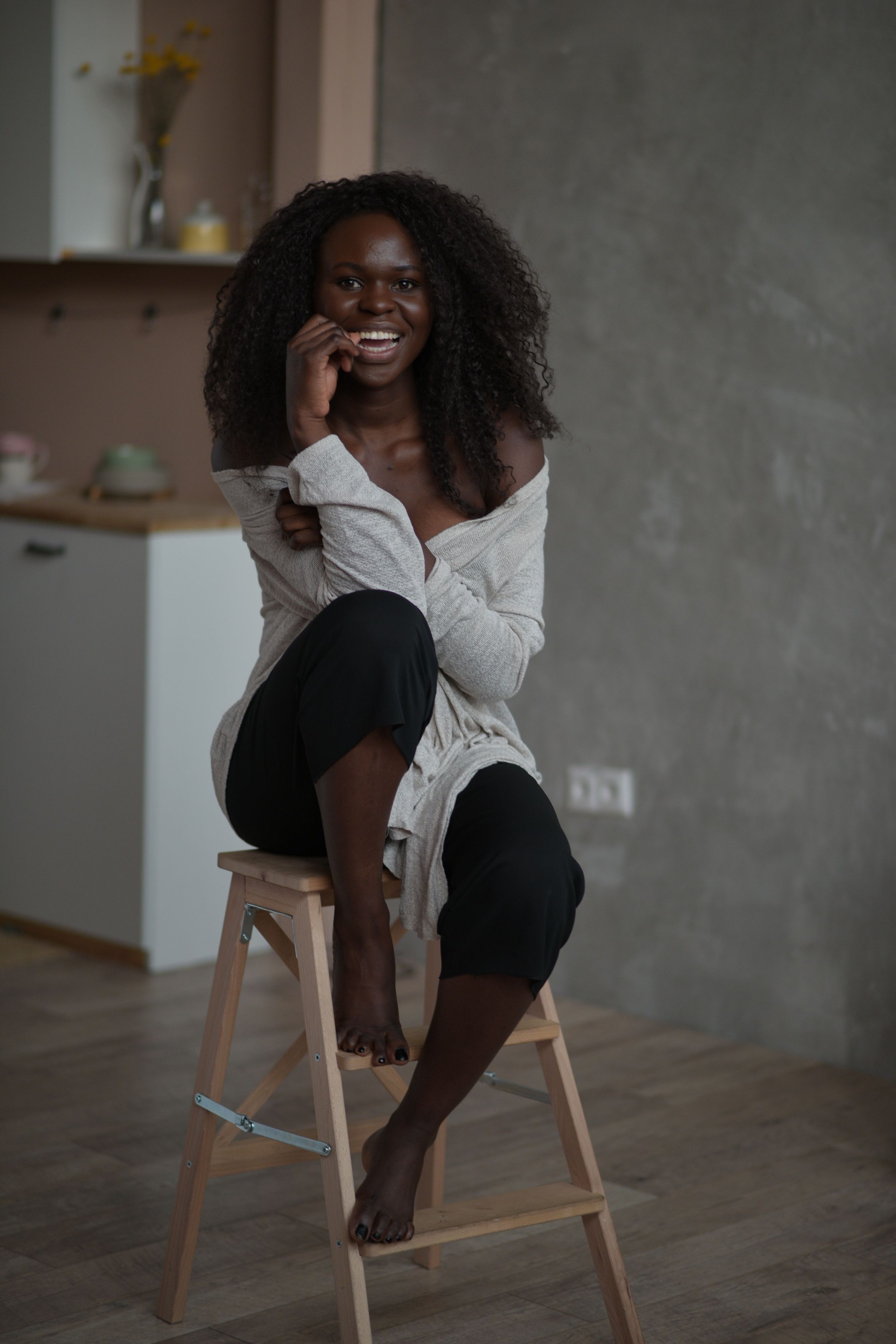 Relaxed Portrait of Smiling Woman on Ladder · Free Stock Photo