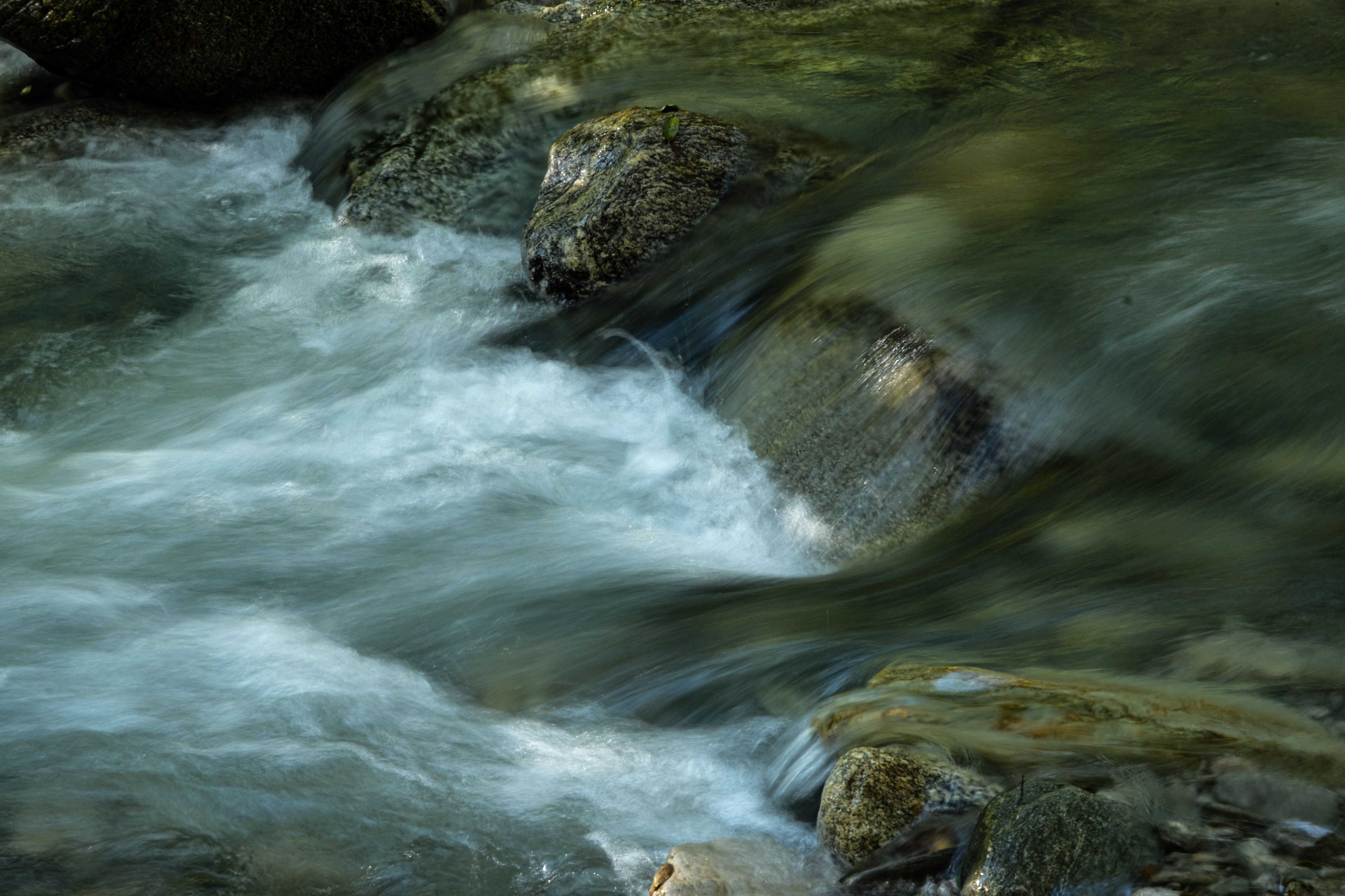 Serene Flowing Stream Over Rocks · Free Stock Photo