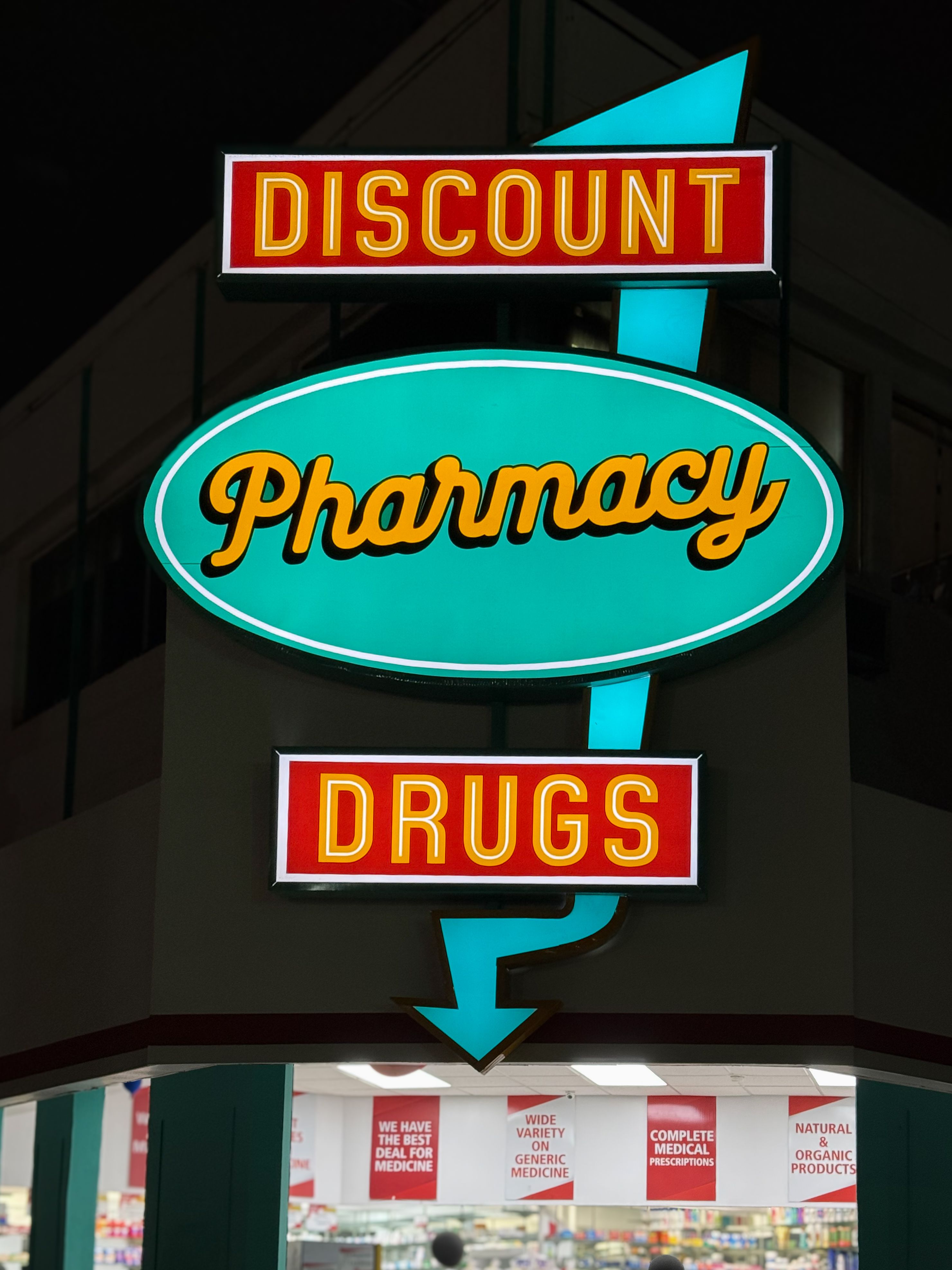 A pharmacy sign hanging from a building · Free Stock Photo