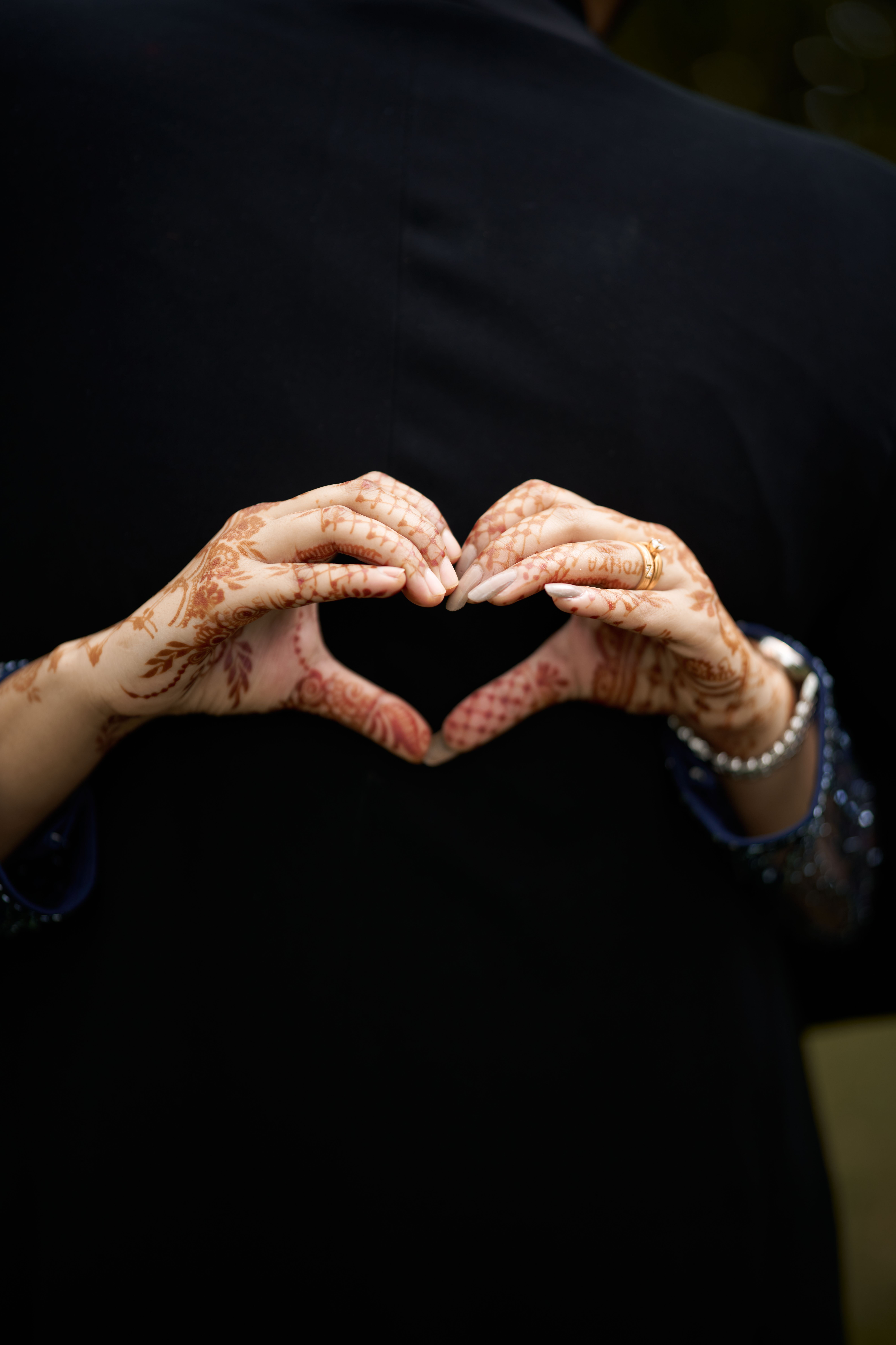 Henna Adorned Hands Creating Heart Shape · Free Stock Photo