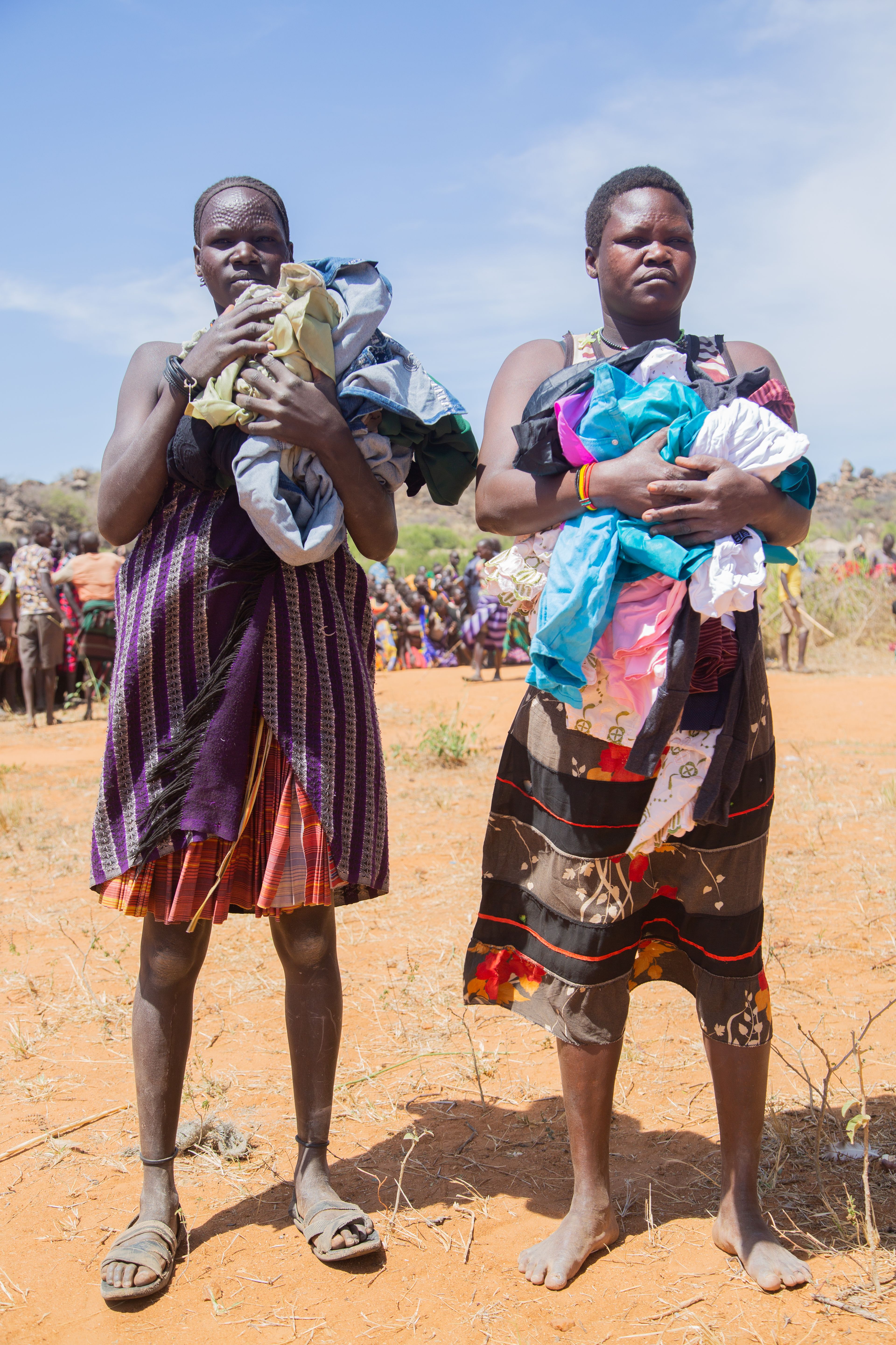 African women holding clothes outdoors · Free Stock Photo