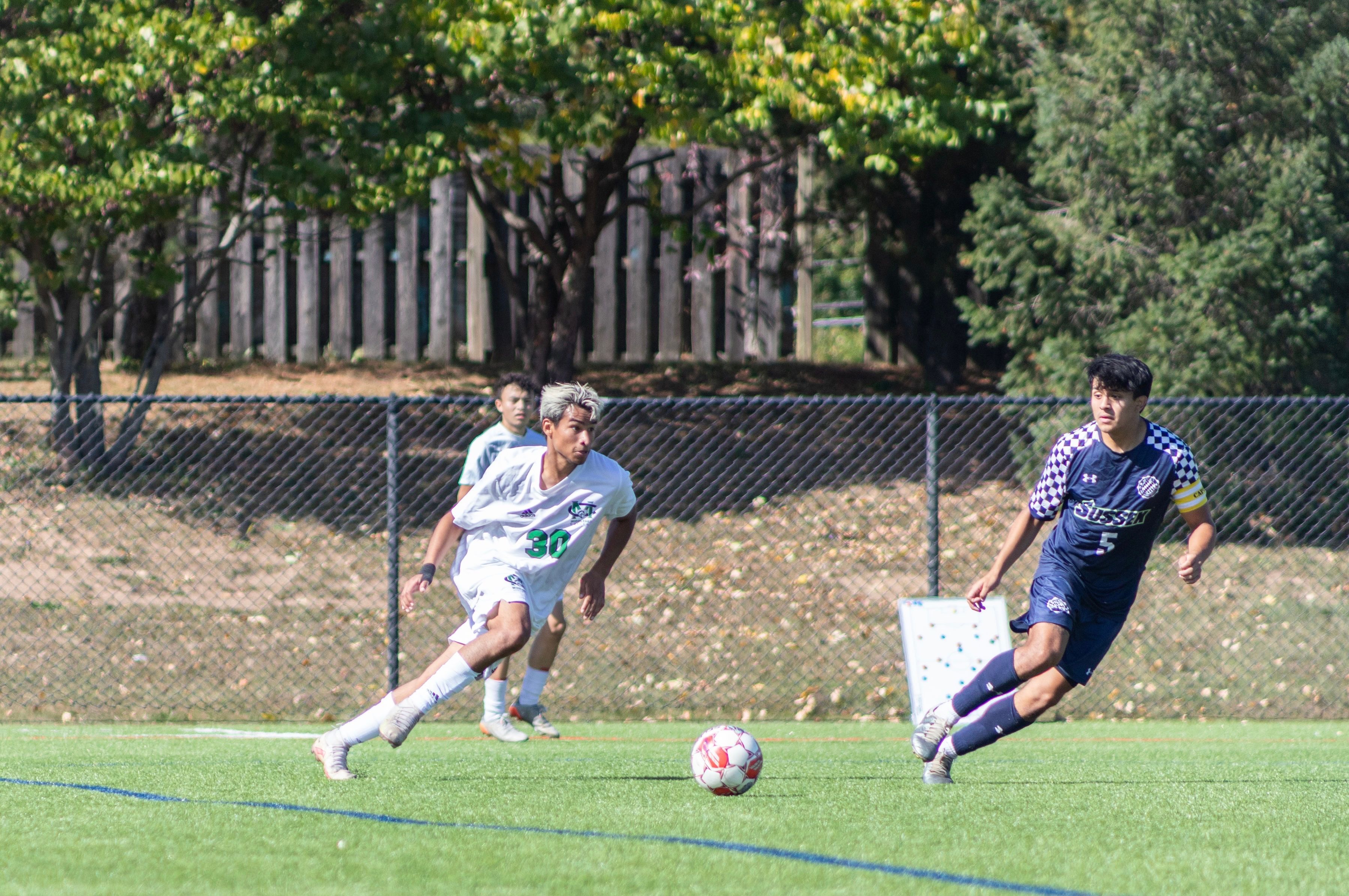 Intense Soccer Match Action on Outdoor Field · Free Stock Photo