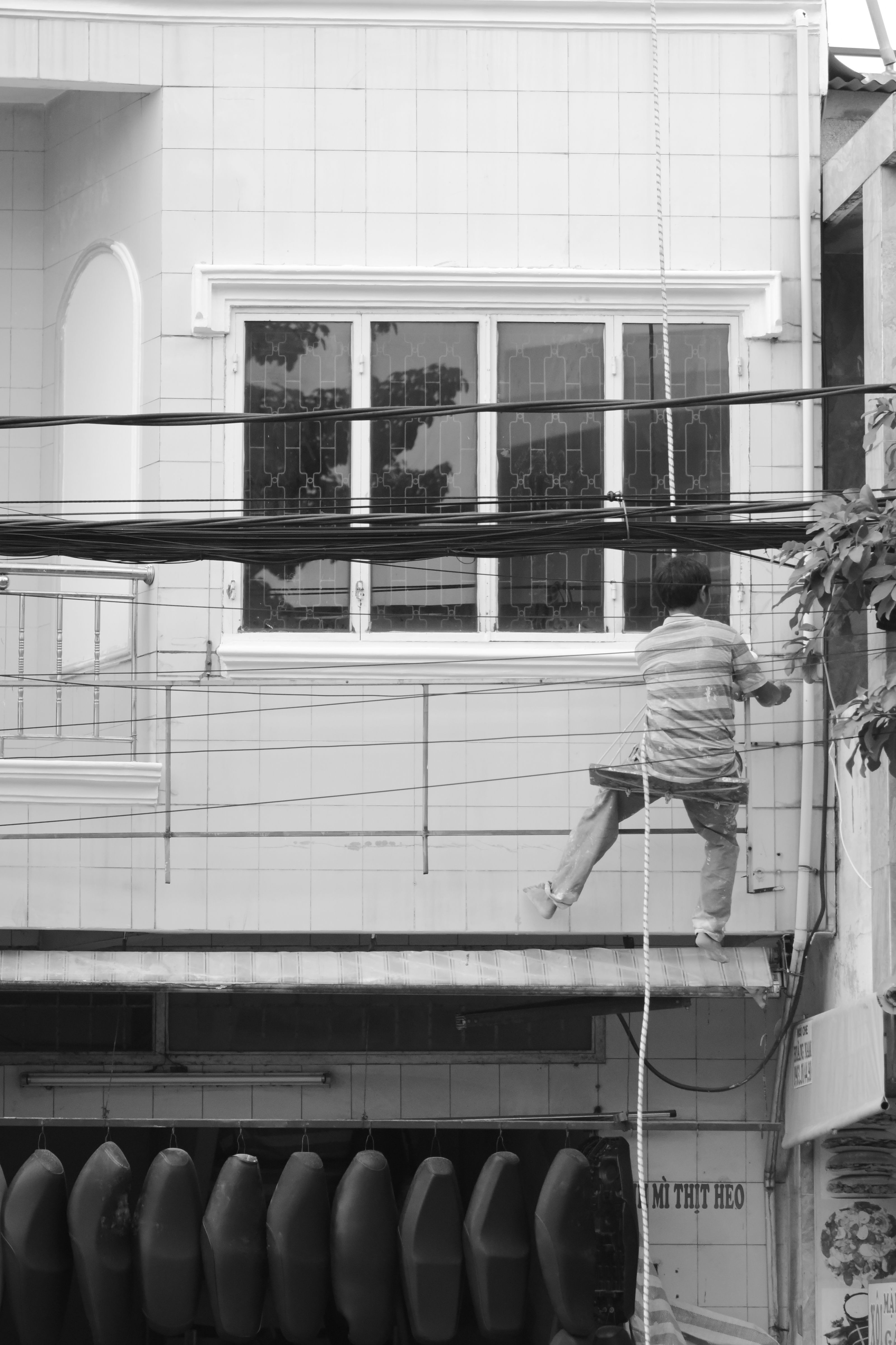 Worker Suspended on Facade of Urban Building · Free Stock Photo