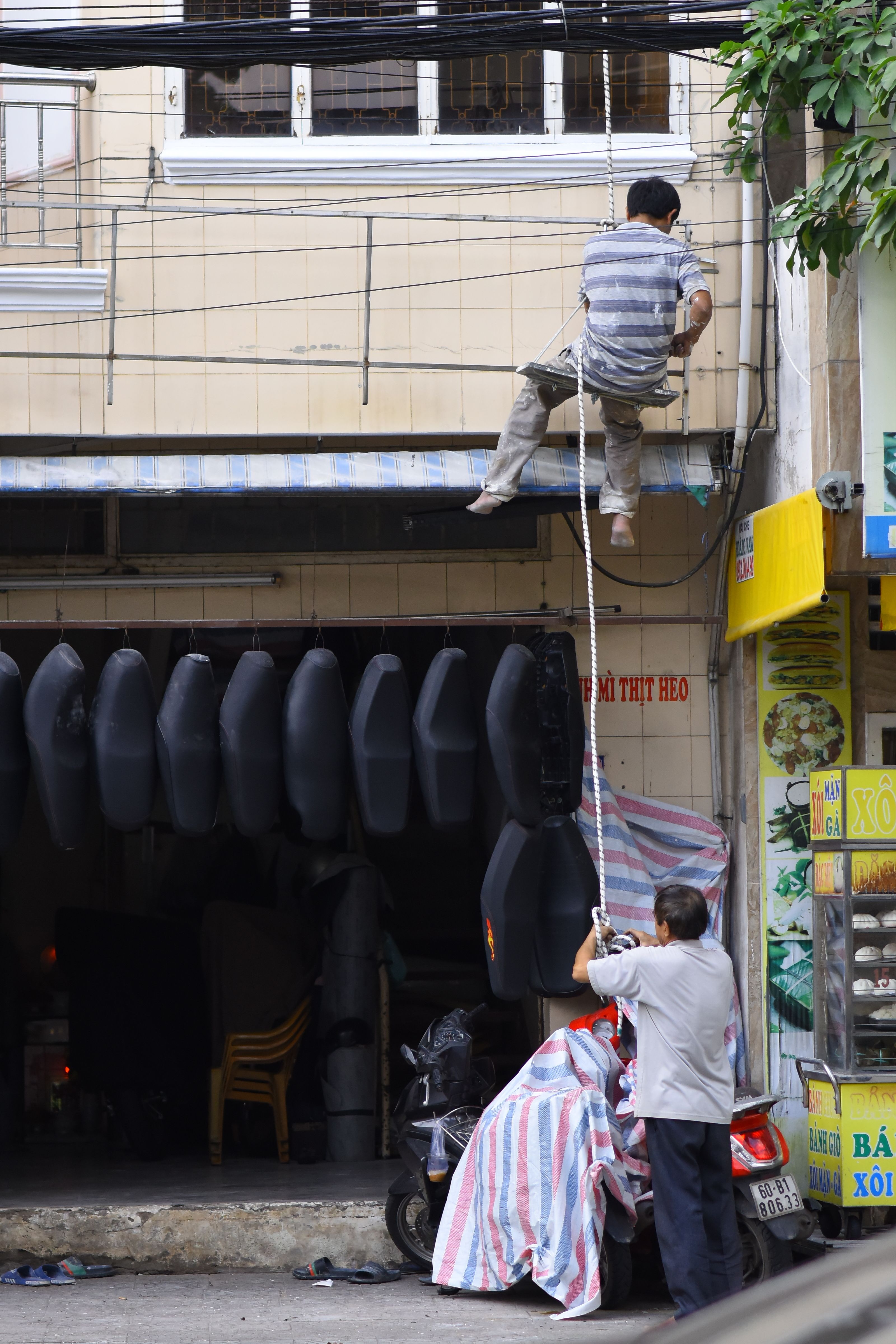 Men Climbing Building Using Rope in Urban Area · Free Stock Photo