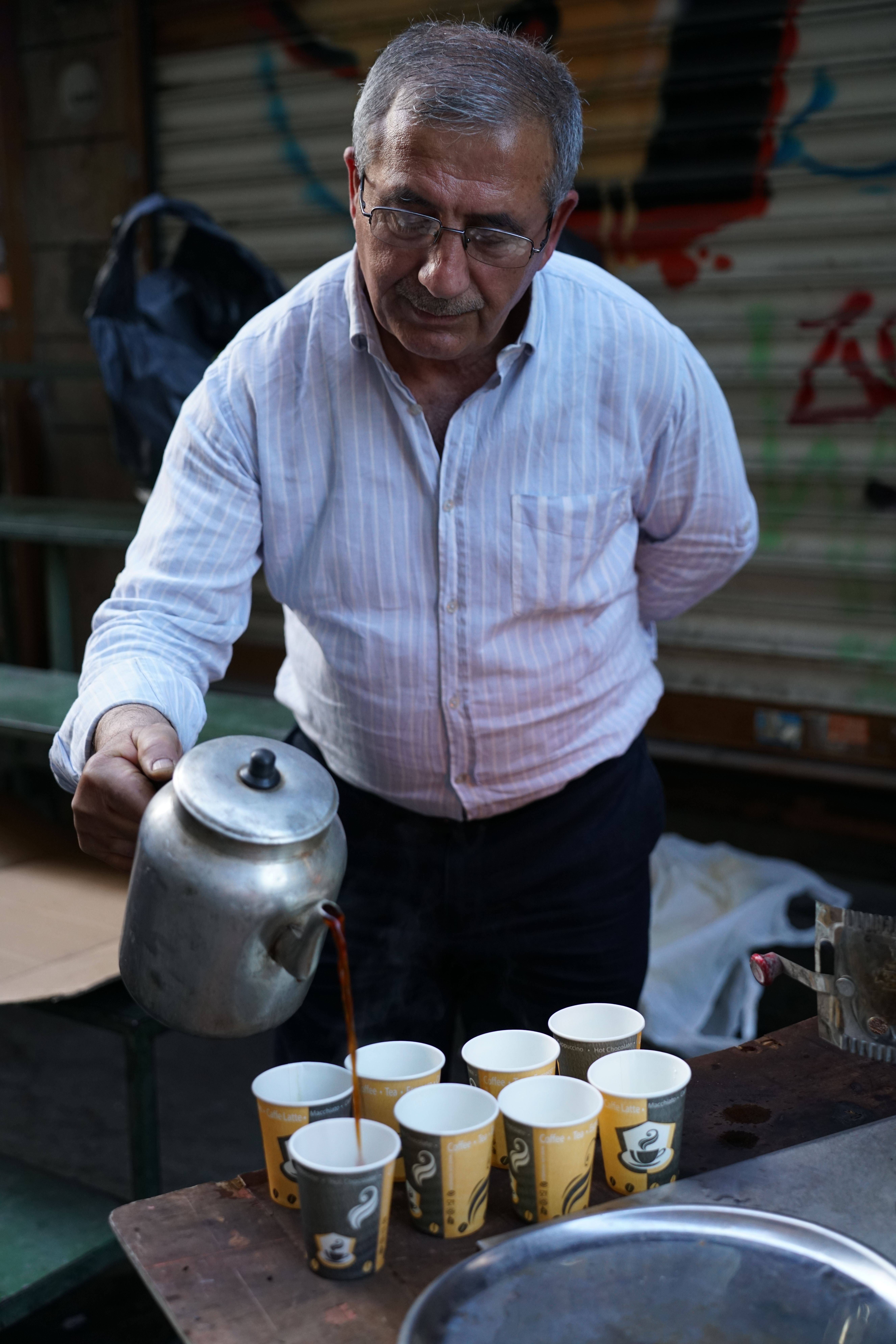 Barista pouring coffee at outdoor cafe · Free Stock Photo