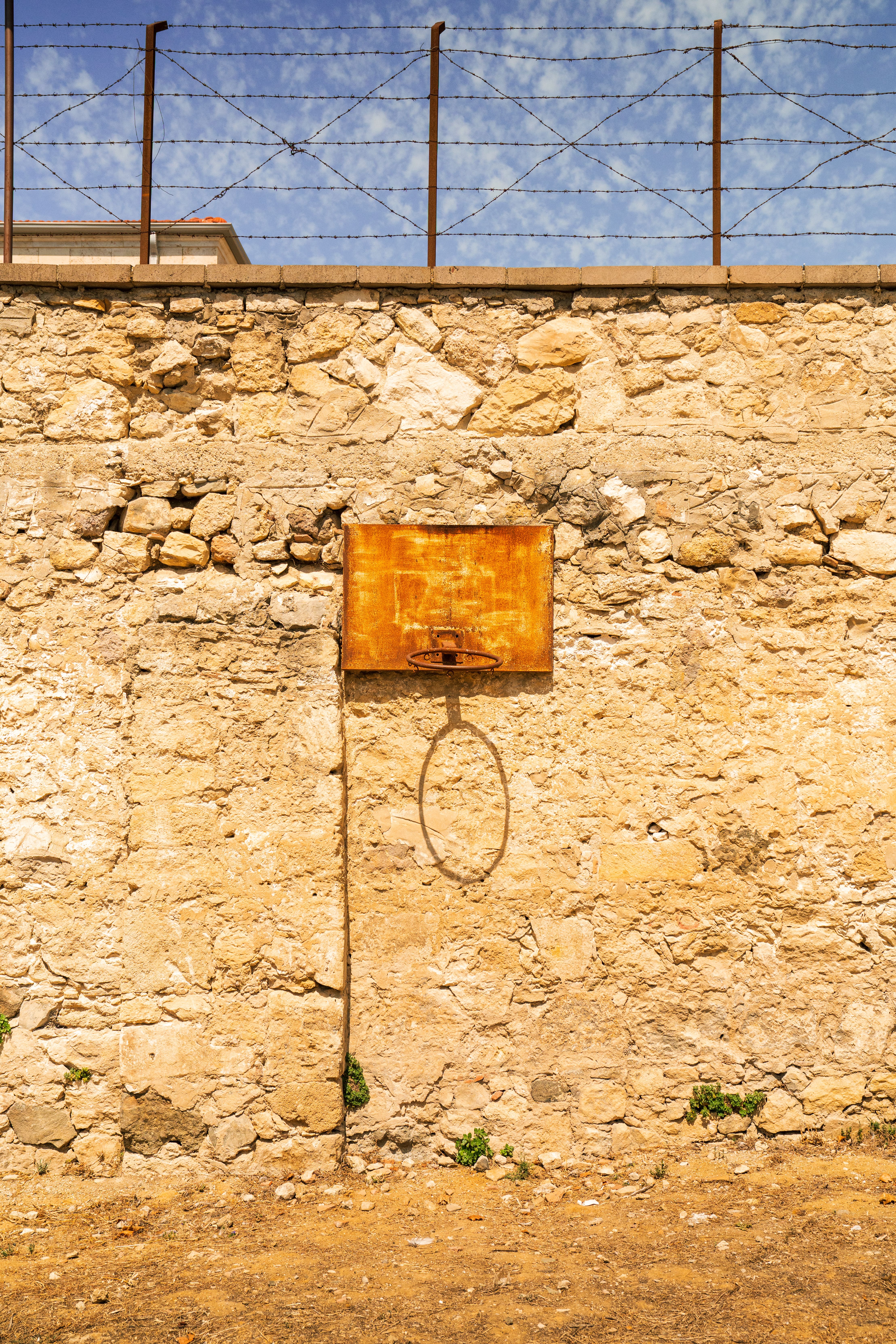 Vintage Rusty Basketball Hoop on Stone Wall · Free Stock Photo