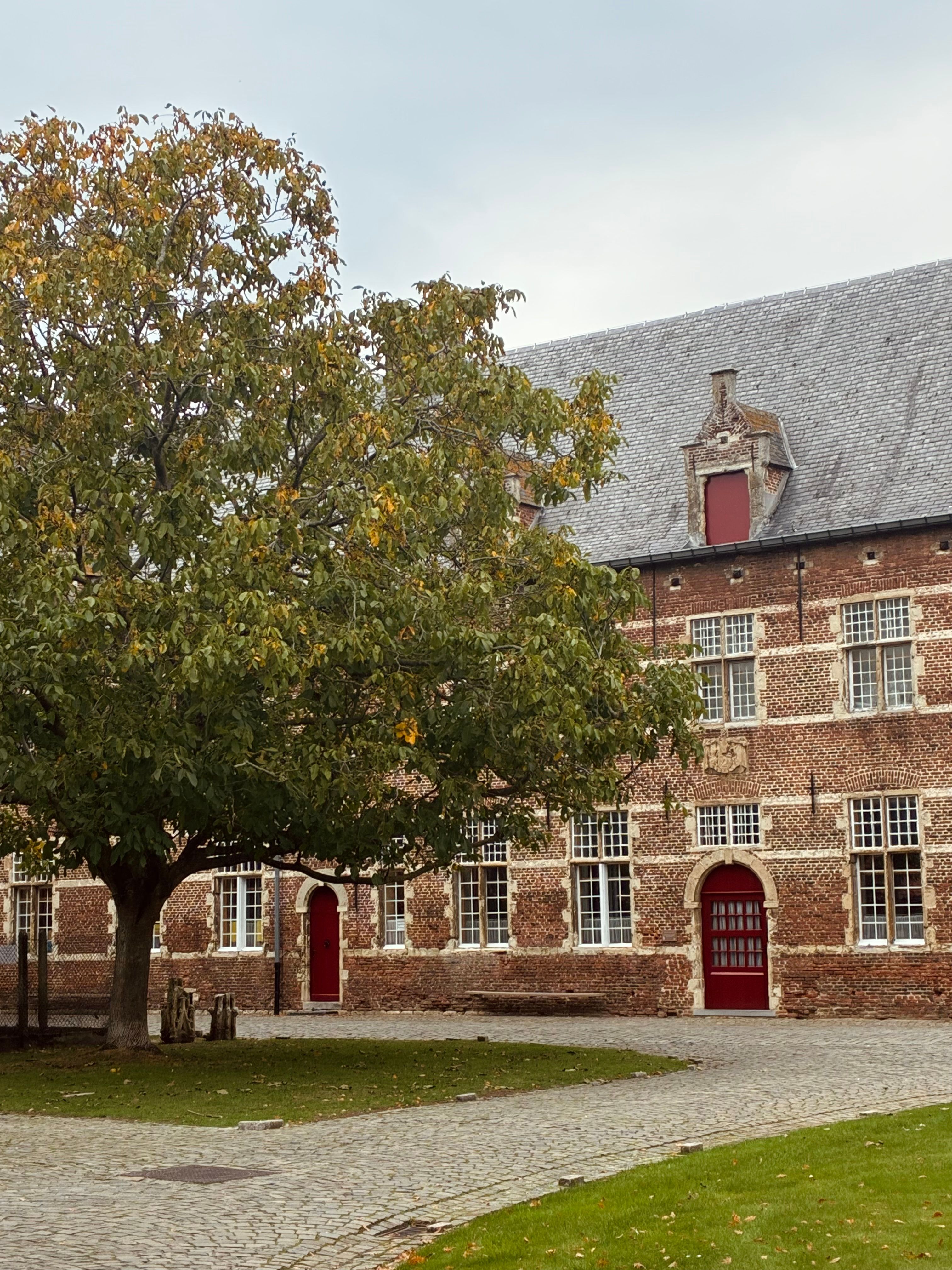 Historic Belgian Building with Cobblestone Path · Free Stock Photo