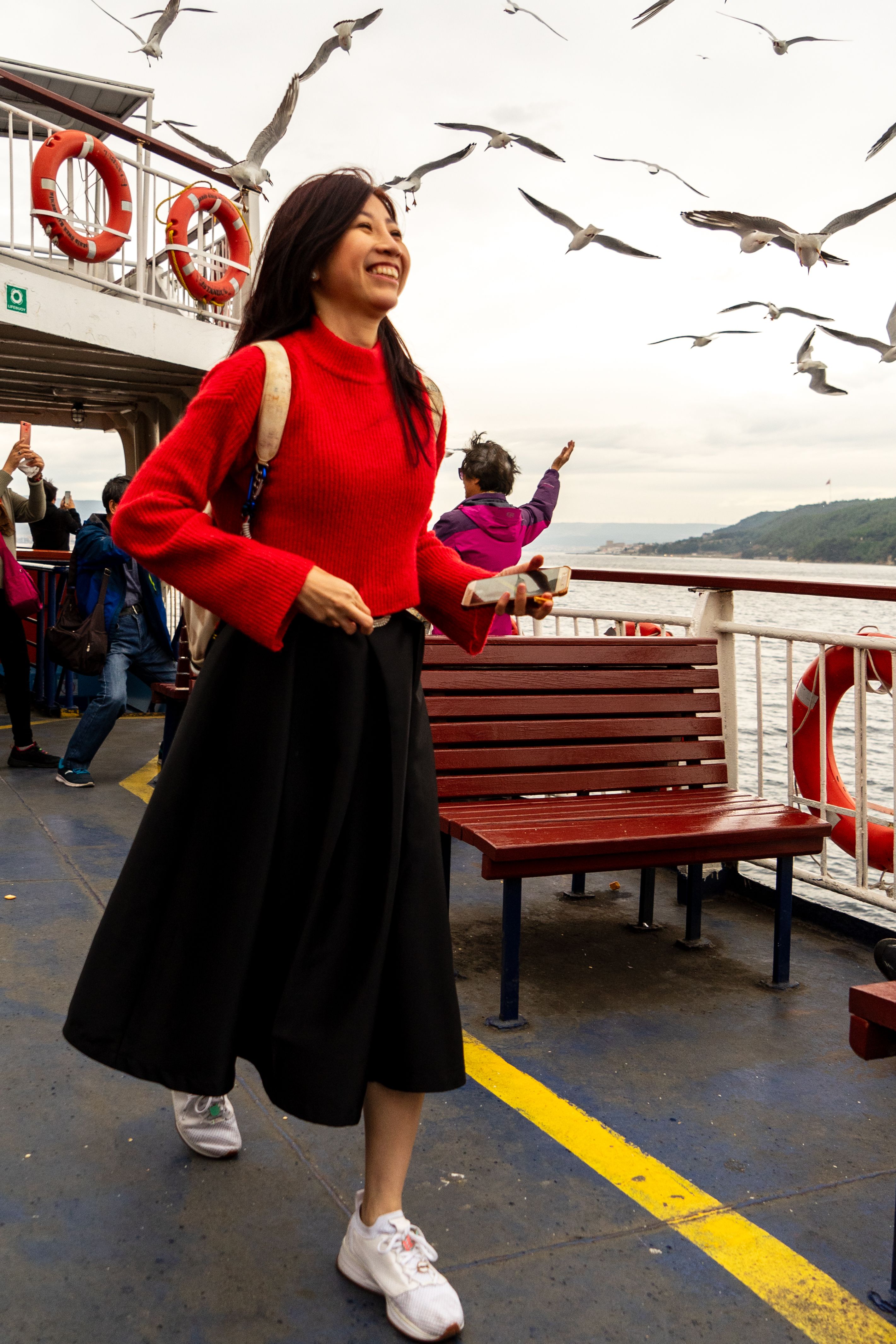 Woman Enjoying Ferry Ride with Seagulls · Free Stock Photo