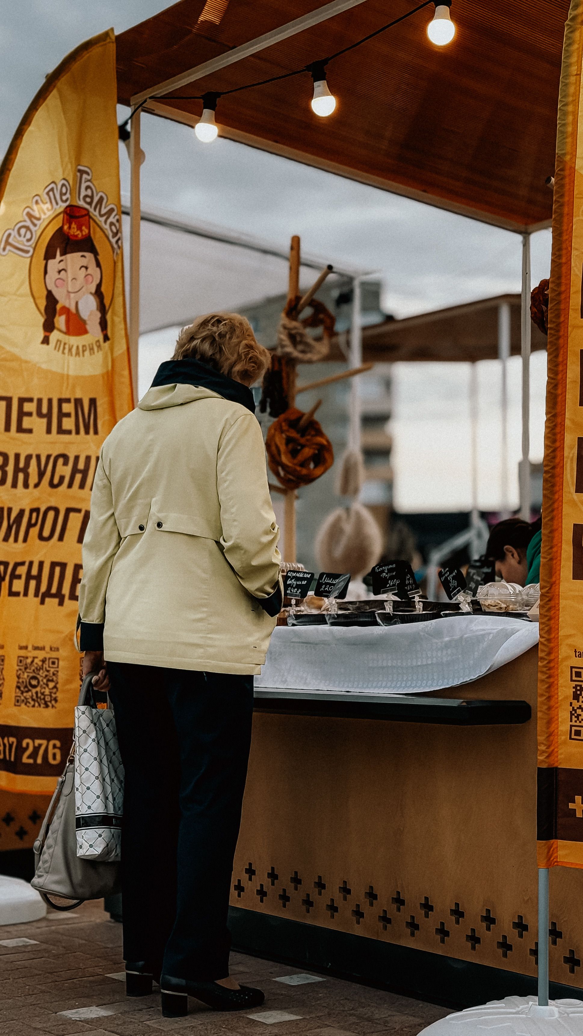 Woman at Outdoor Bakery Stall during Daytime · Free Stock Photo