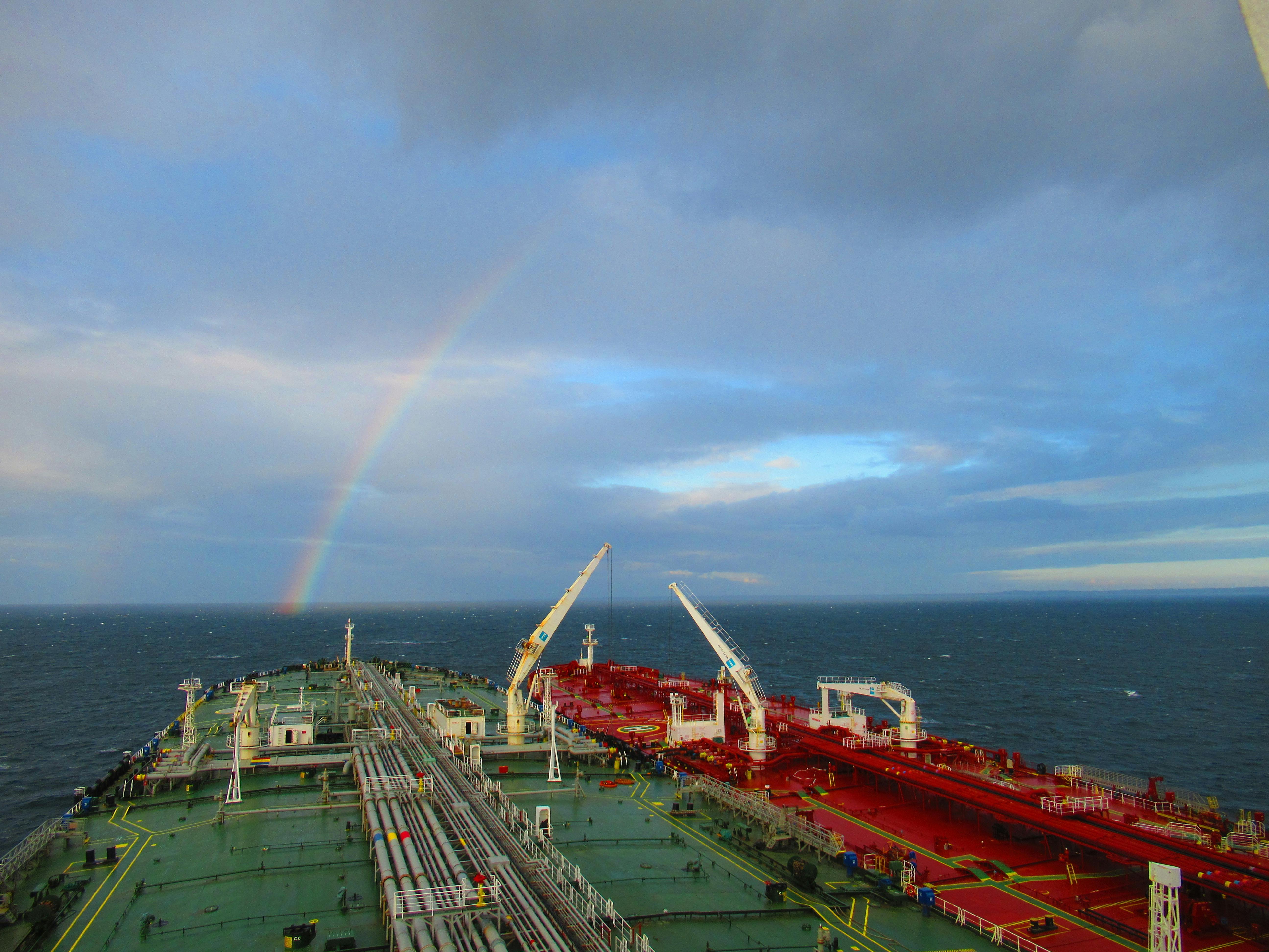 Industrial Cargo Ship with Rainbow over Ocean · Free Stock Photo