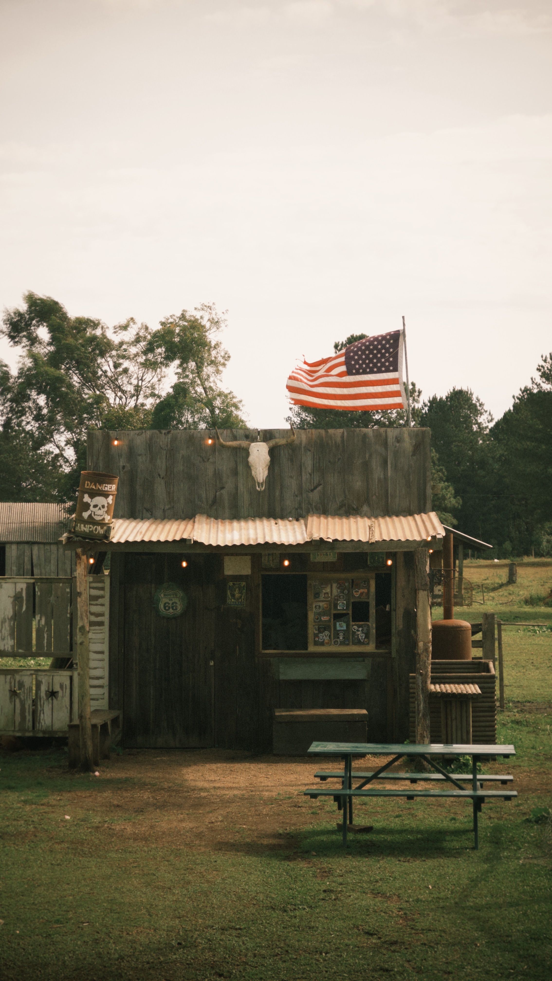 Rustic American Cabin with Flag in Countryside · Free Stock Photo