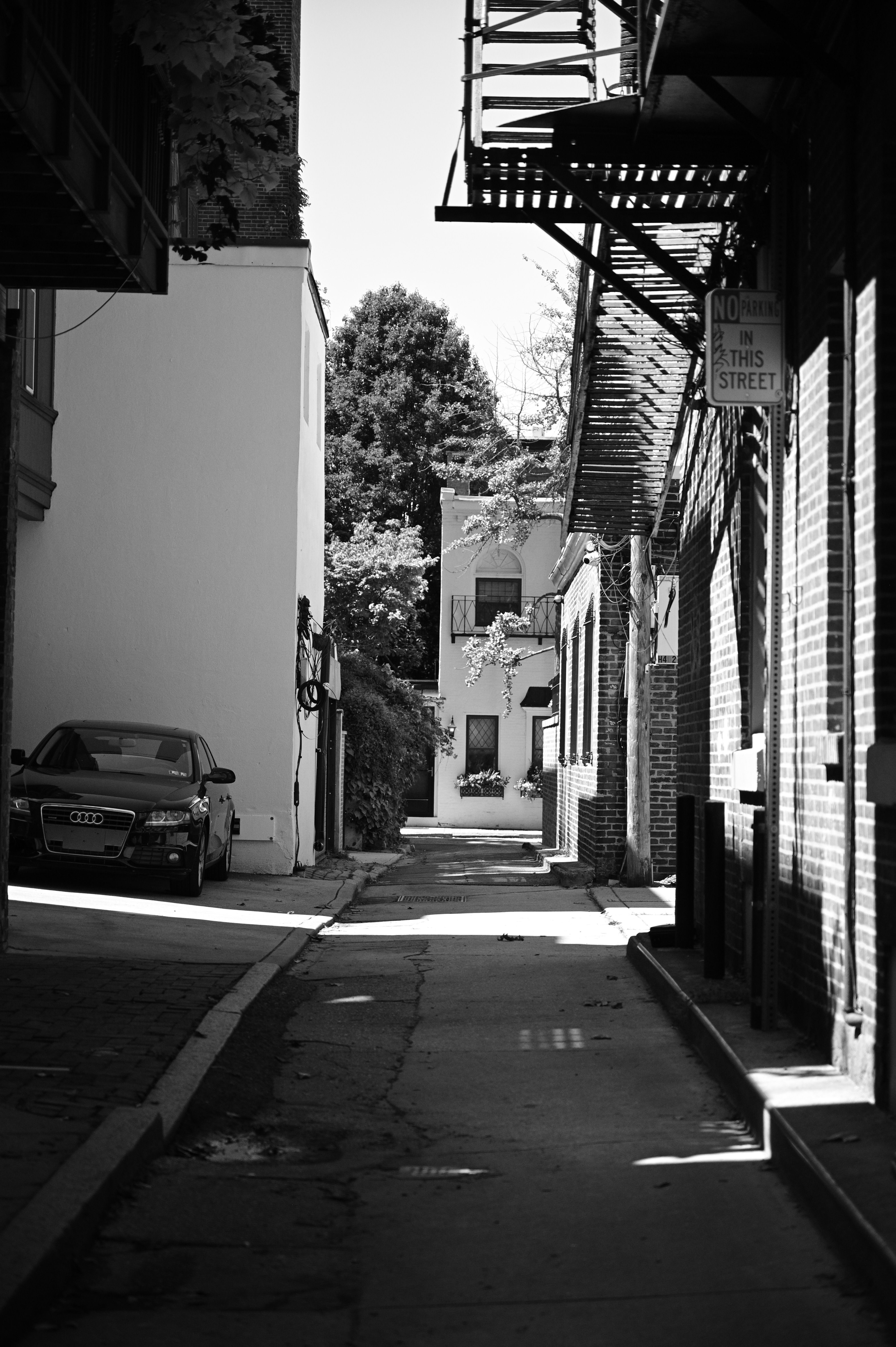 Black and White Urban Alleyway with Car · Free Stock Photo