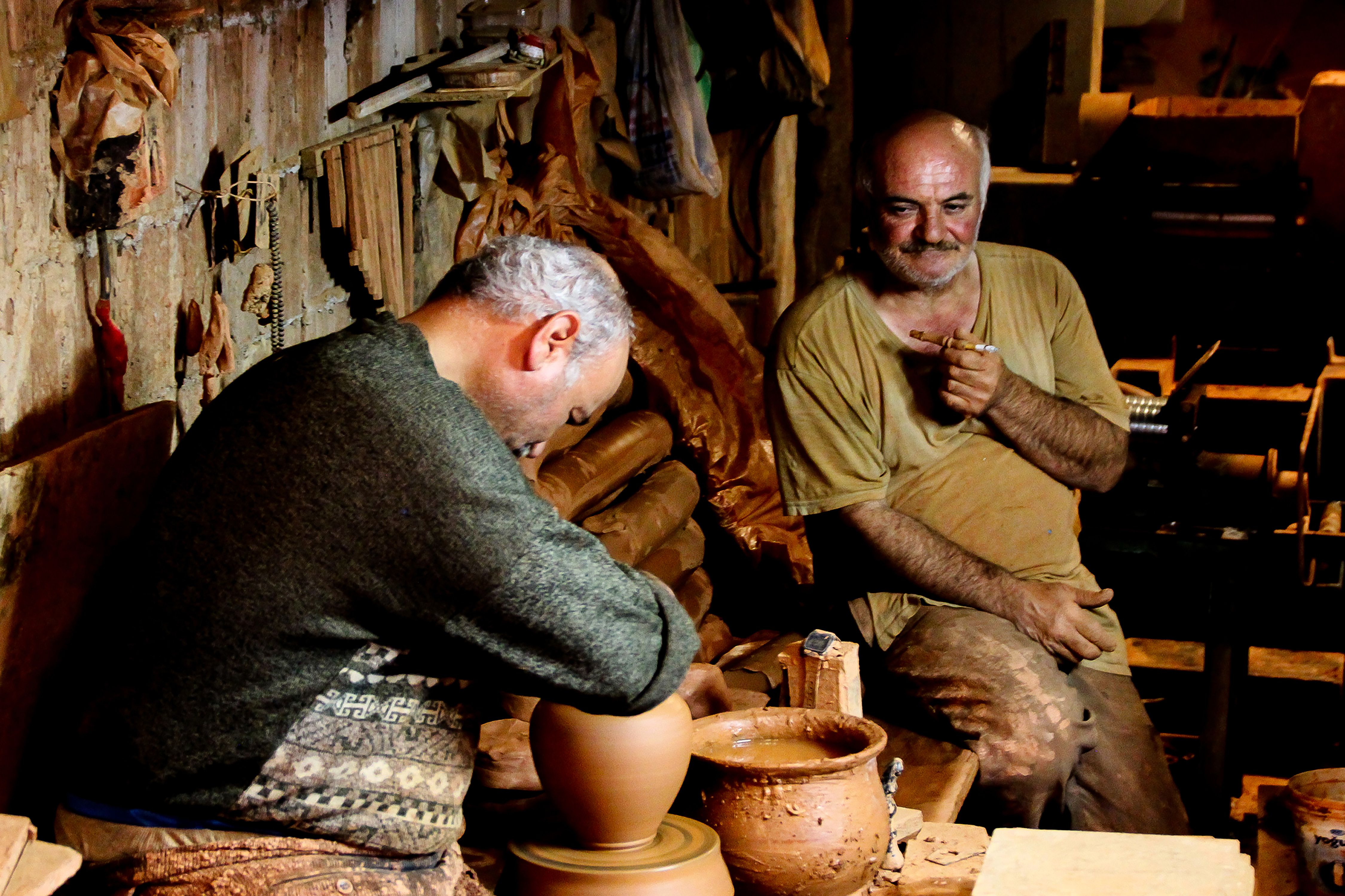 Artisan Potters Crafting Clay Pots in Workshop · Free Stock Photo