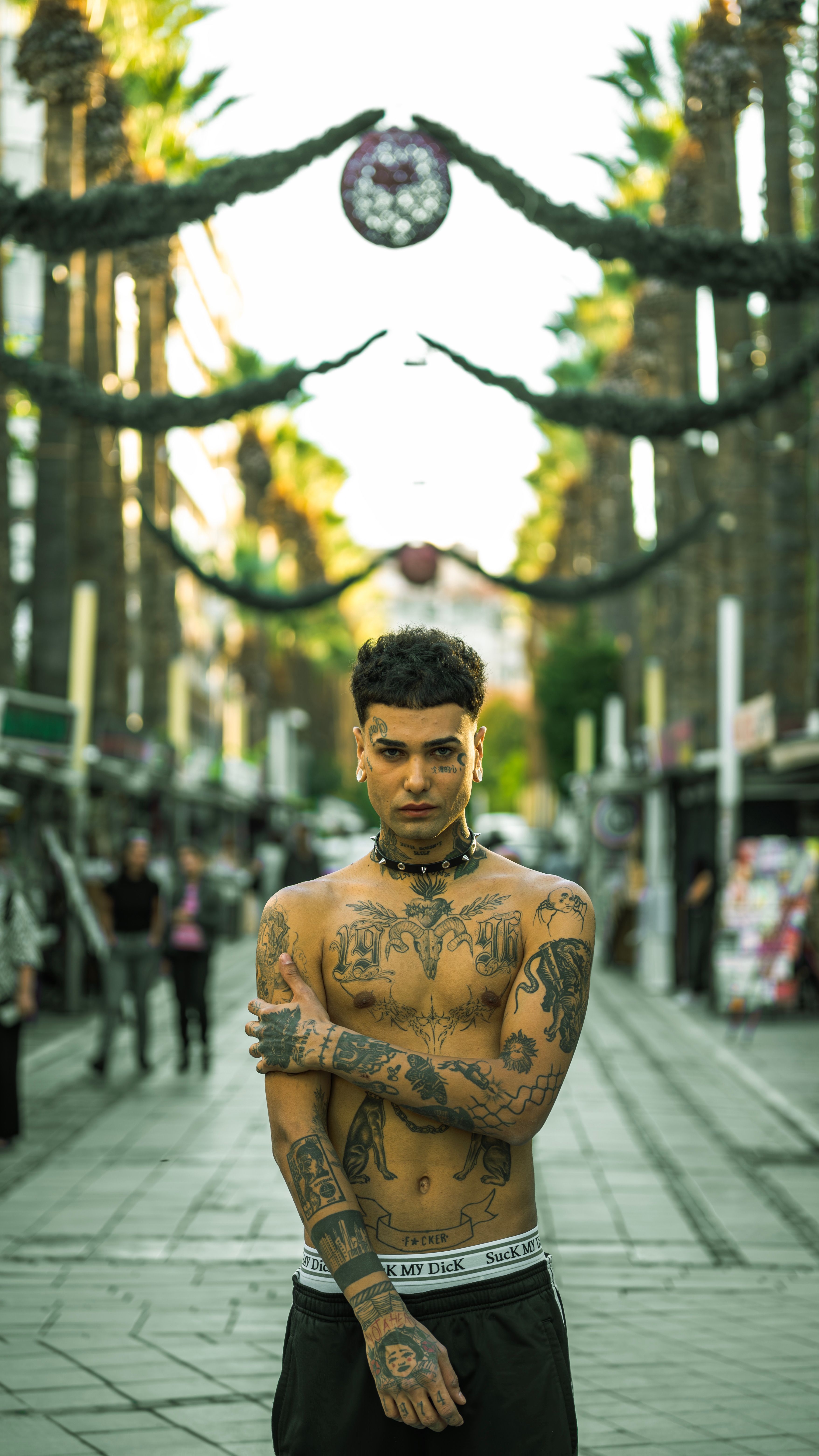 Tattoo Covered Person Posing with Arms Crossed in Defiant Pose · Free ...