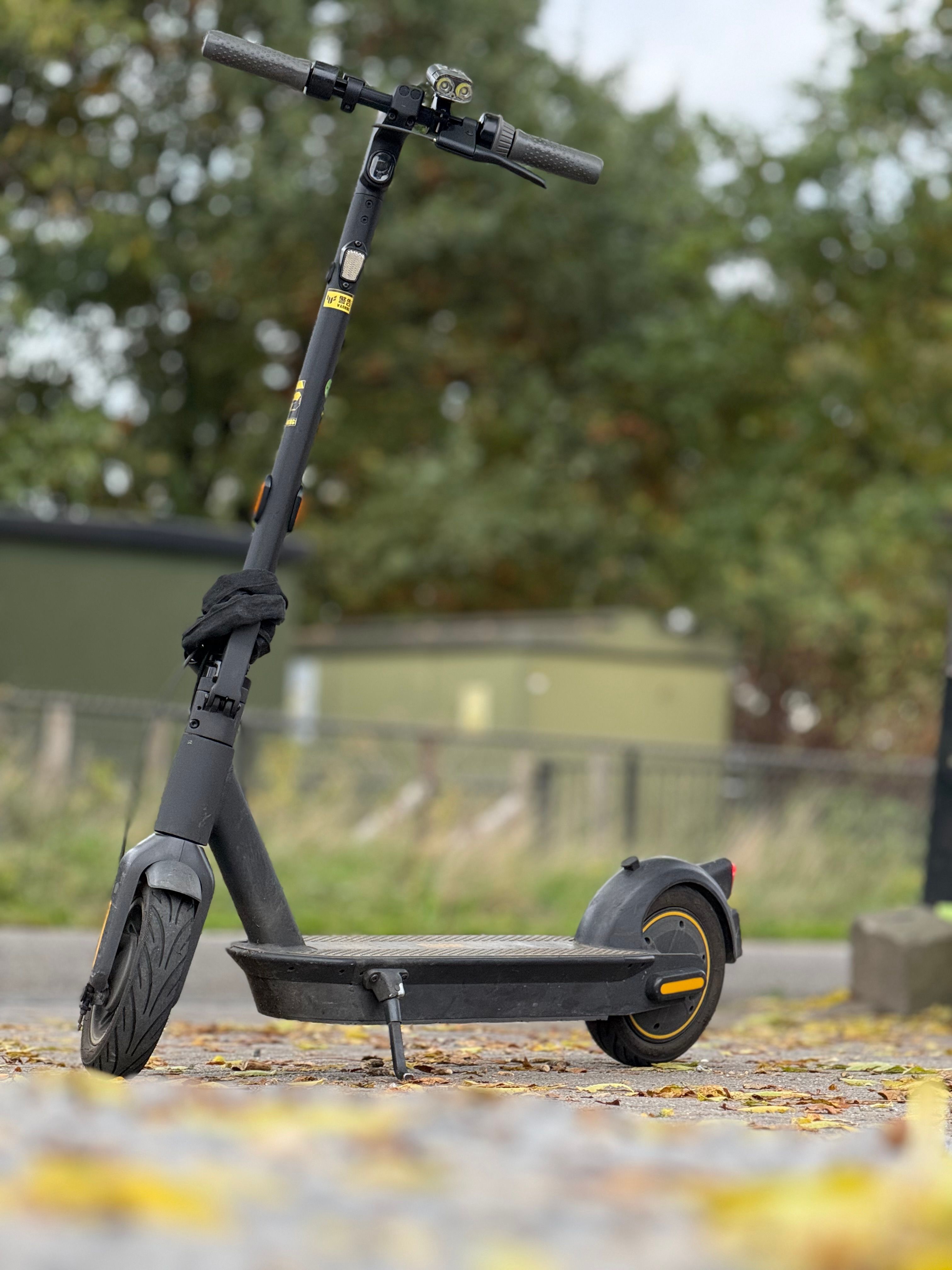 Modern Black Electric Scooter Outdoors on Leafy Path · Free Stock Photo