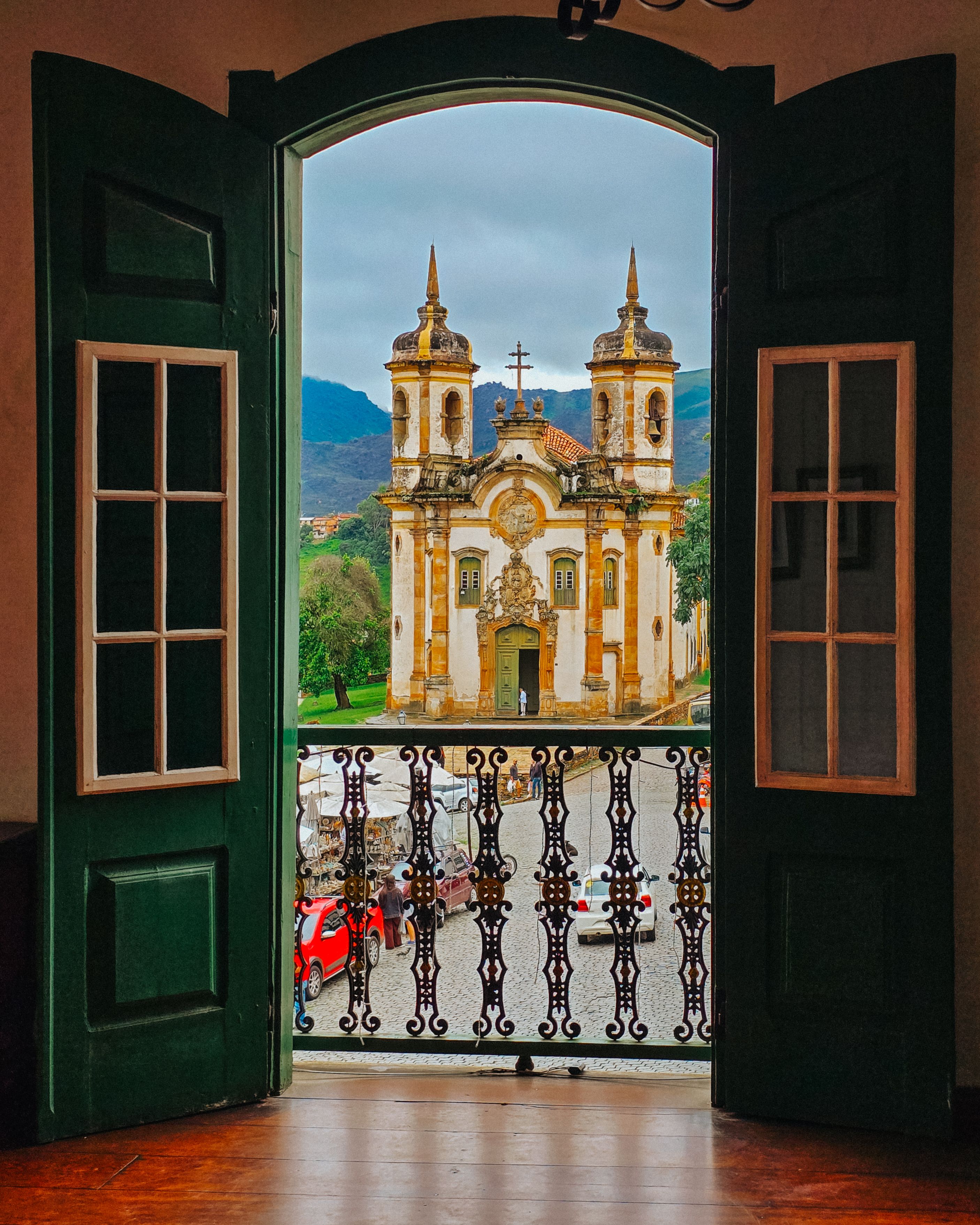 Church View through Elegant Balcony Doors · Free Stock Photo