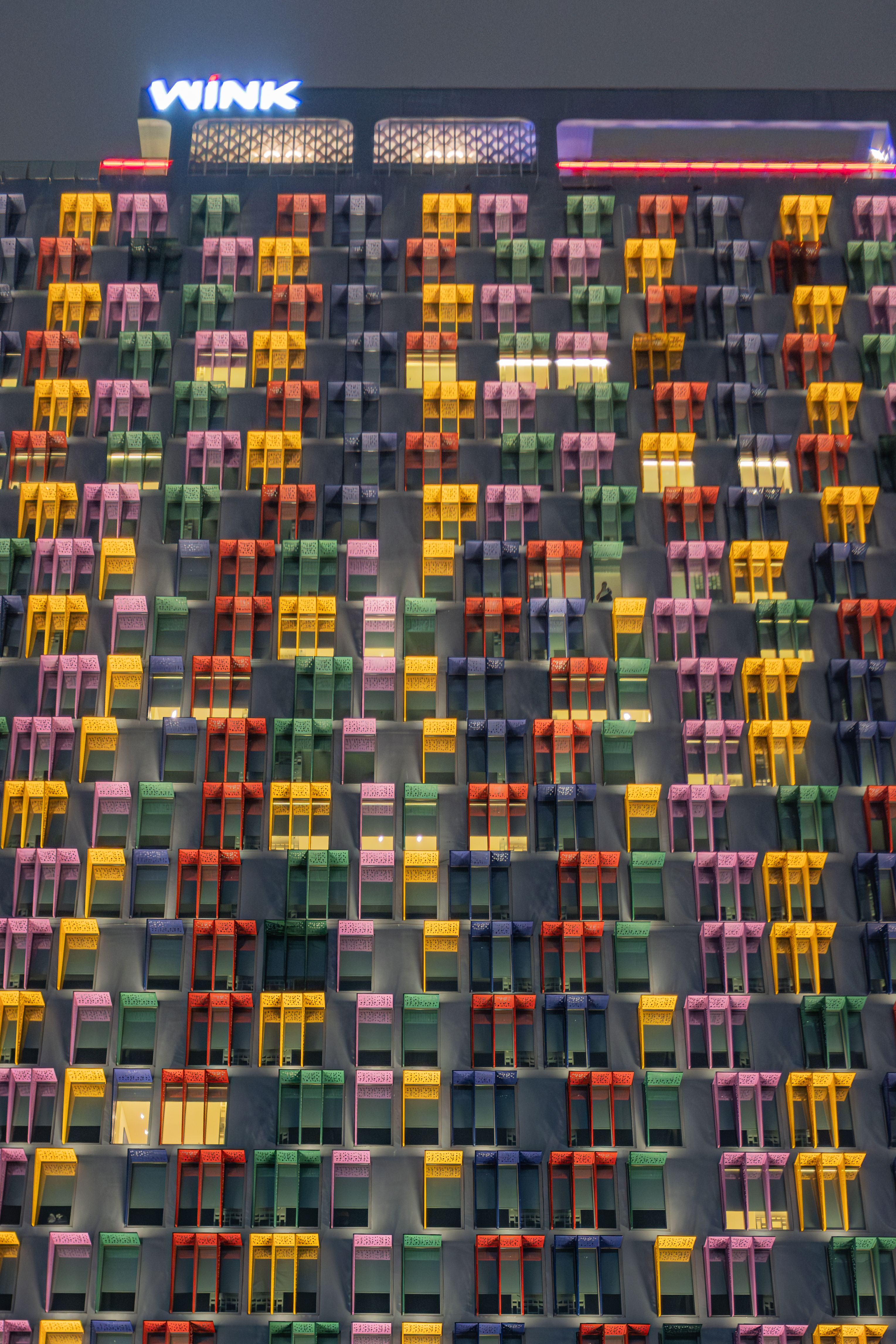 Colorful urban building facade at night · Free Stock Photo