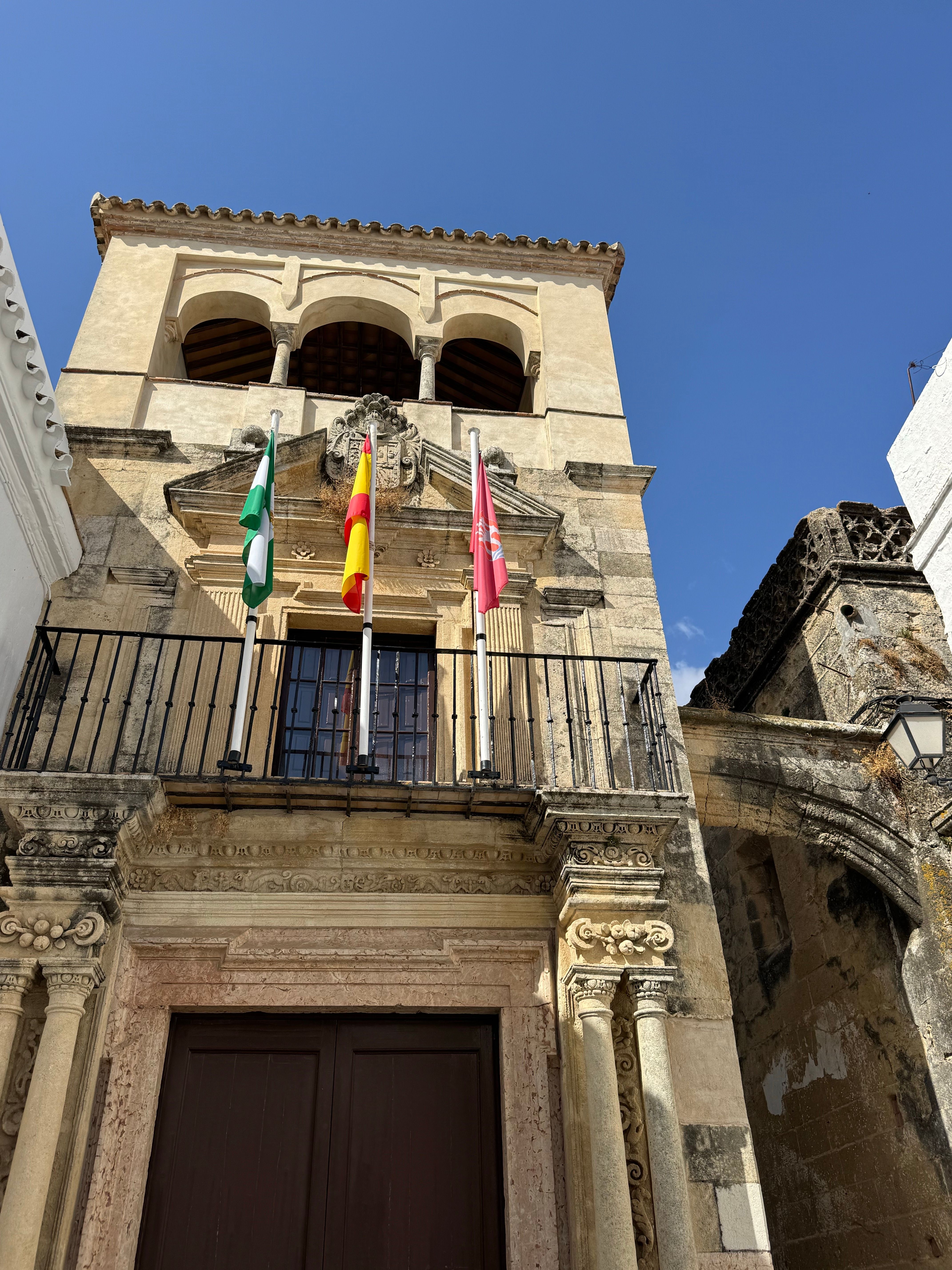 Historic Spanish Building with Flags under Blue Sky · Free Stock Photo