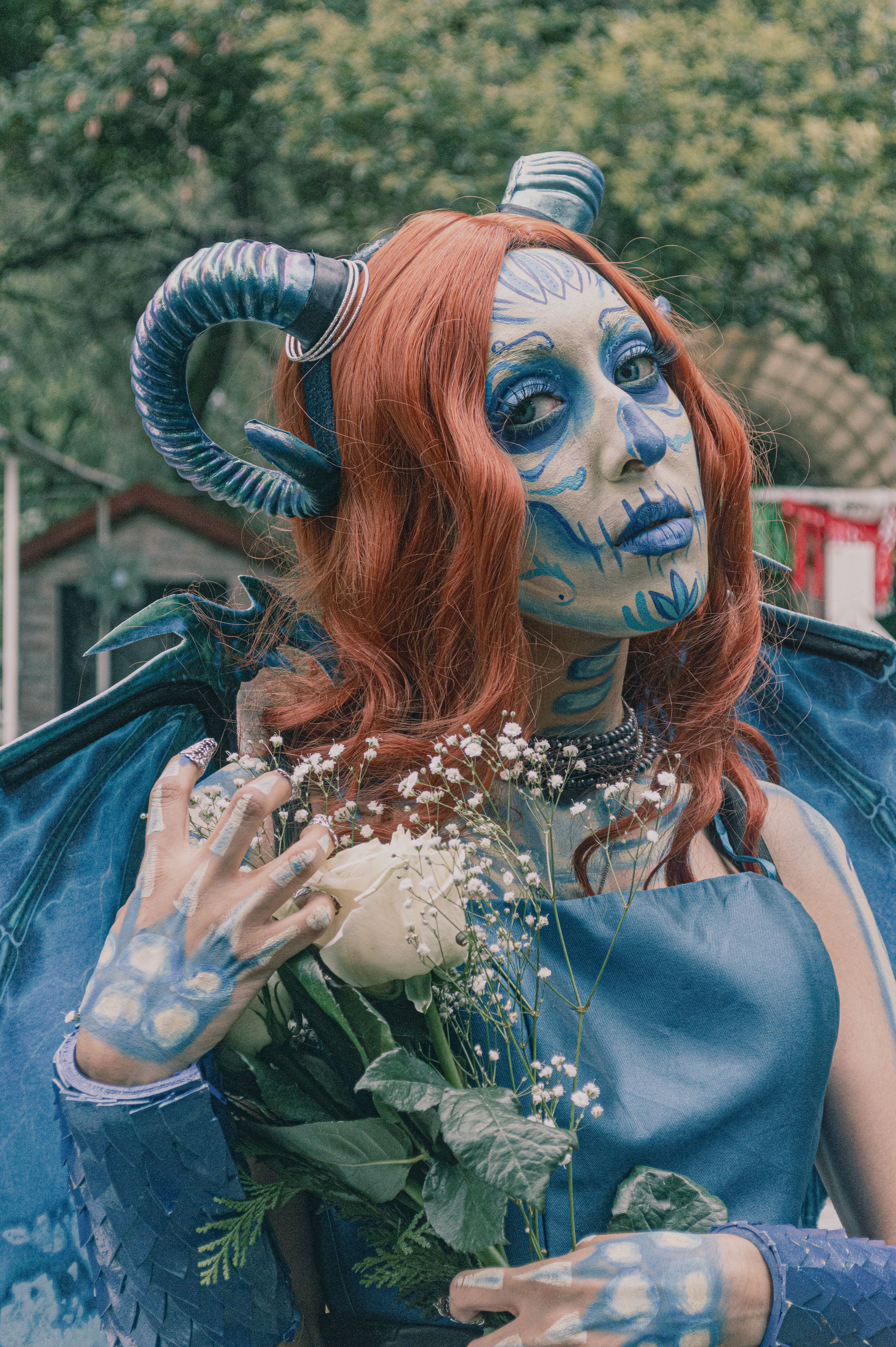 Enchanting Blue Demon Catrina with Floral Bouquet · Free Stock Photo