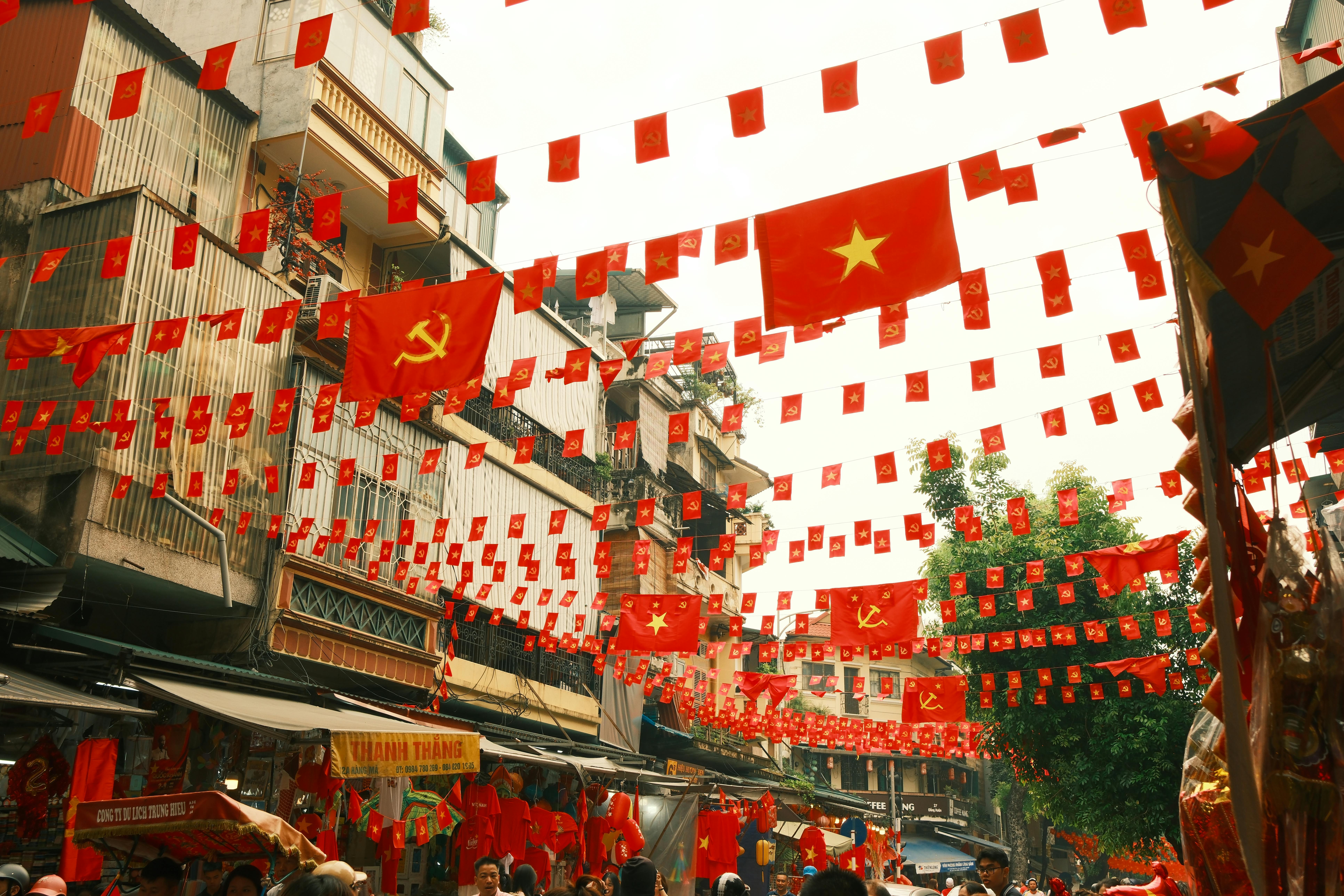 Vietnamese Flag Decorations in Bustling Market Street · Free Stock Photo