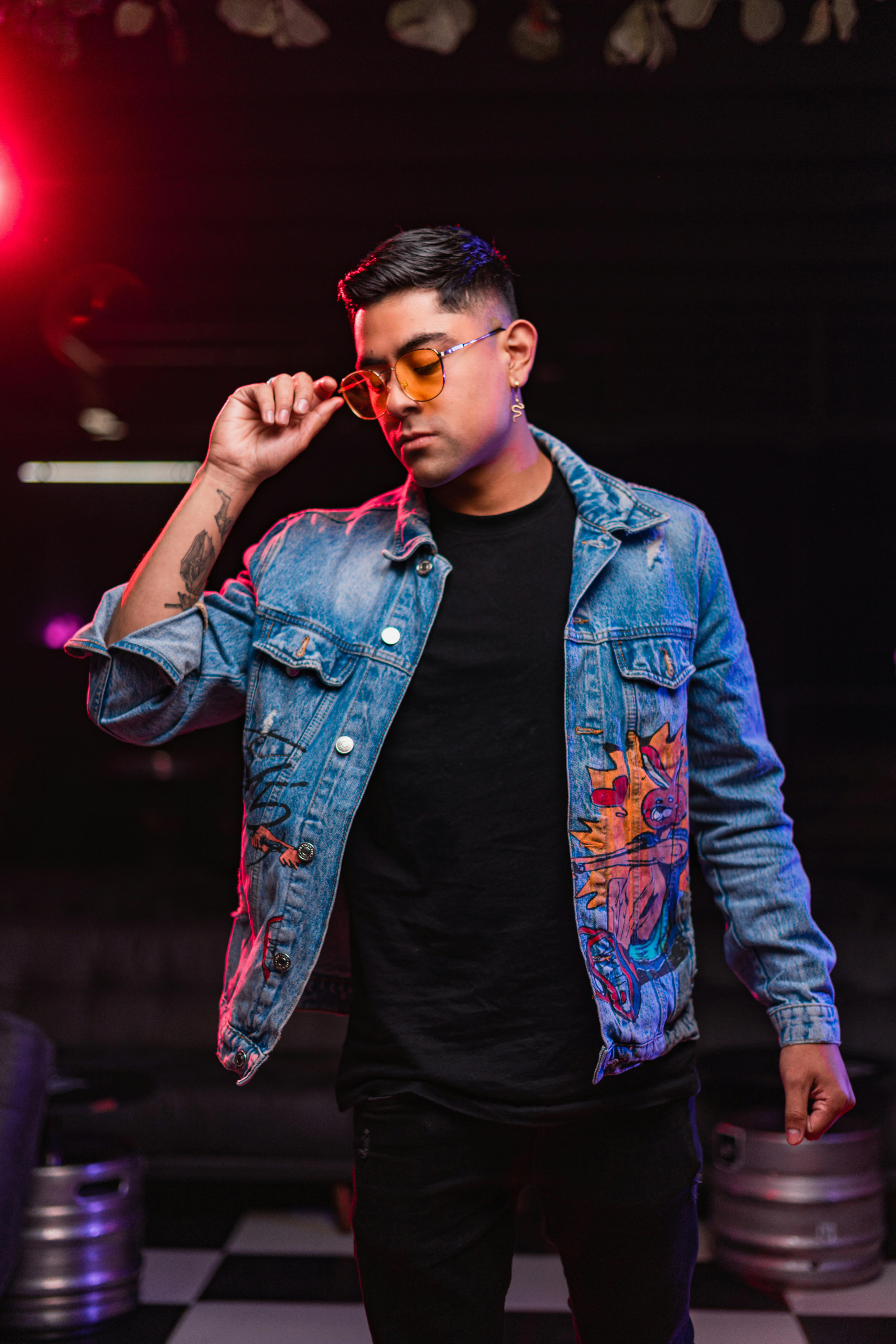 Trendy Young Adult in Denim Jacket at Nightclub · Free Stock Photo
