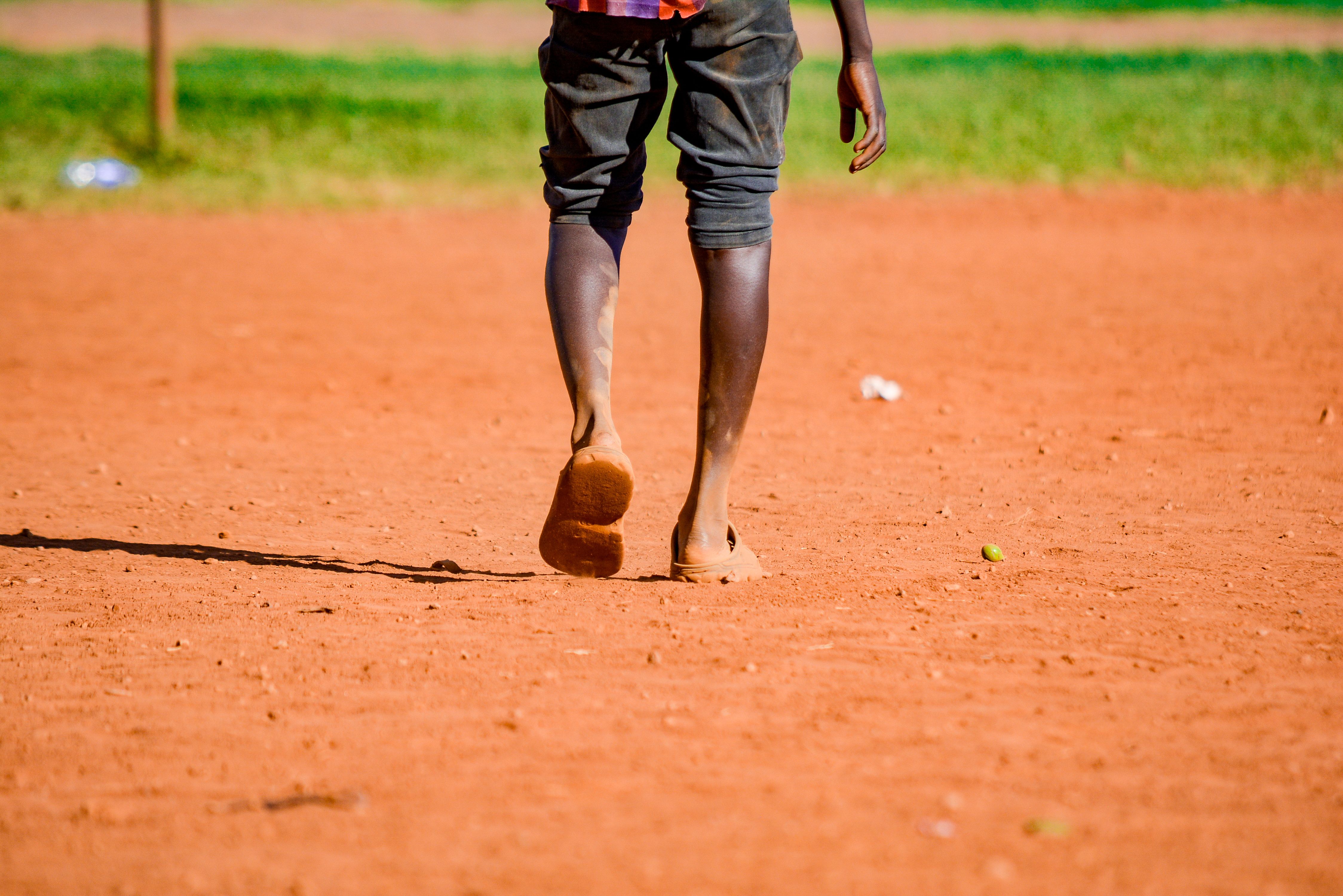 Barefoot Walk on Red Earth in Uganda · Free Stock Photo