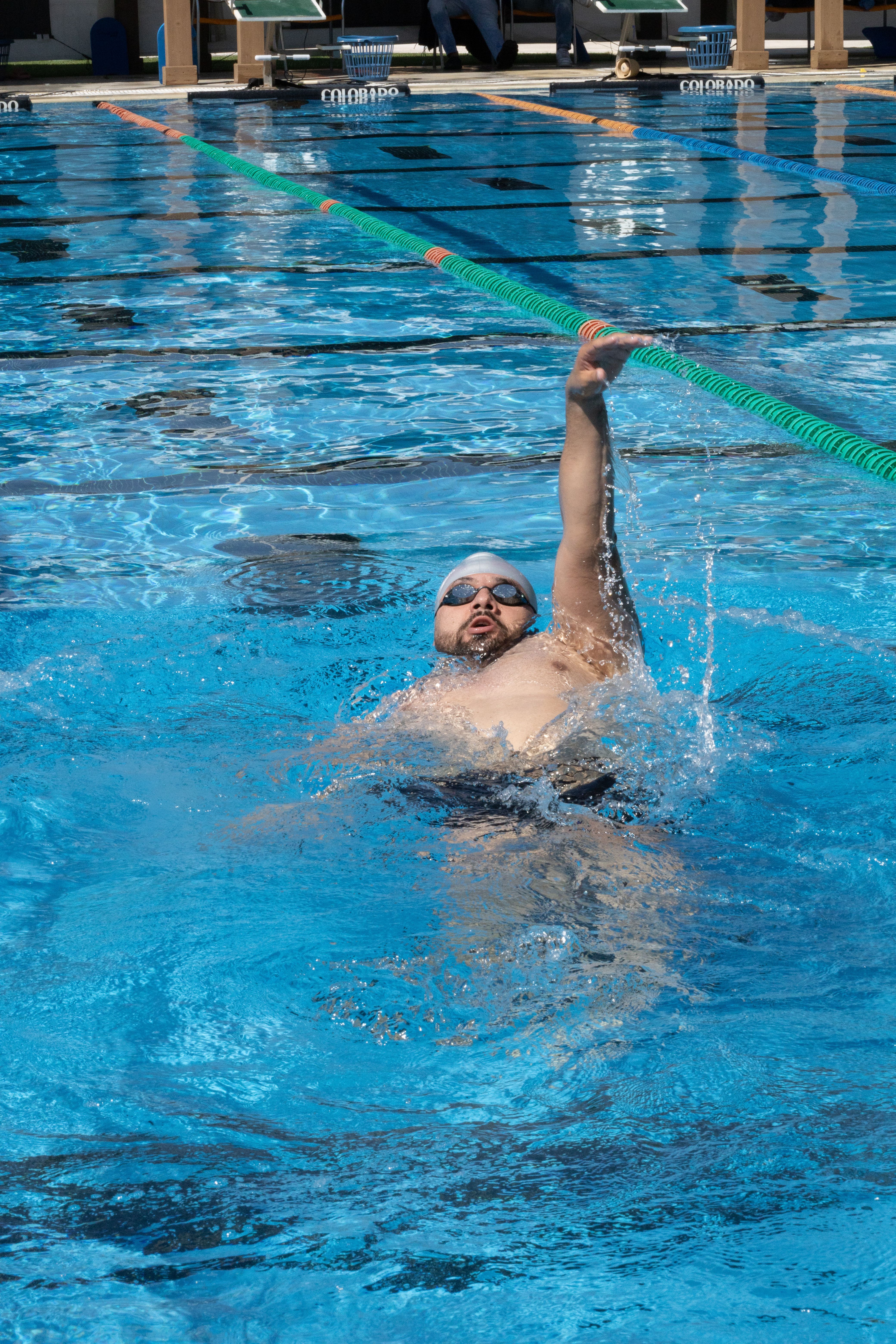 Professional Swimmer Performing Backstroke in Pool · Free Stock Photo