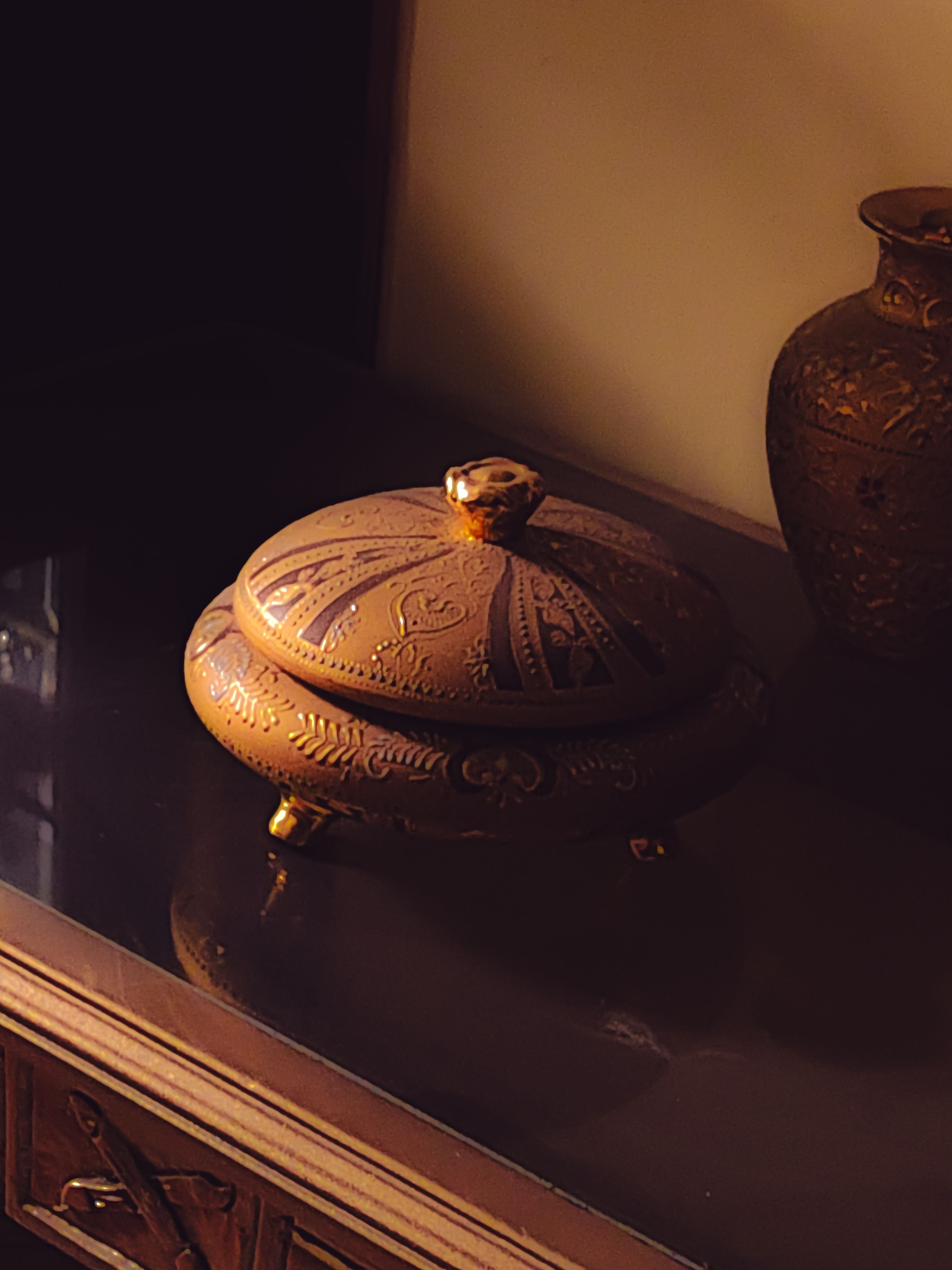 Elegant Decorative Bronze Container on Table · Free Stock Photo