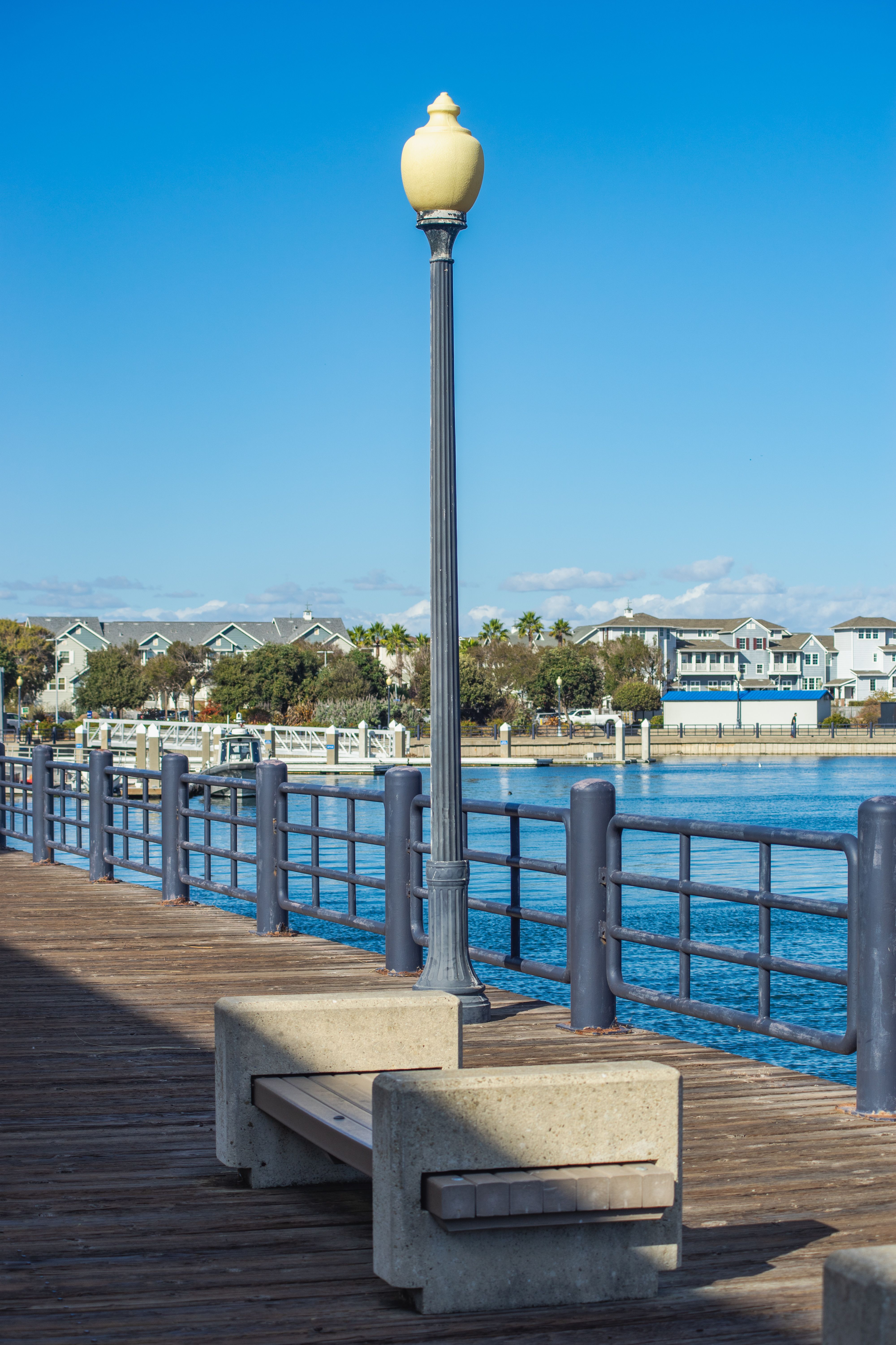 Scenic Waterfront Promenade with Empty Bench · Free Stock Photo