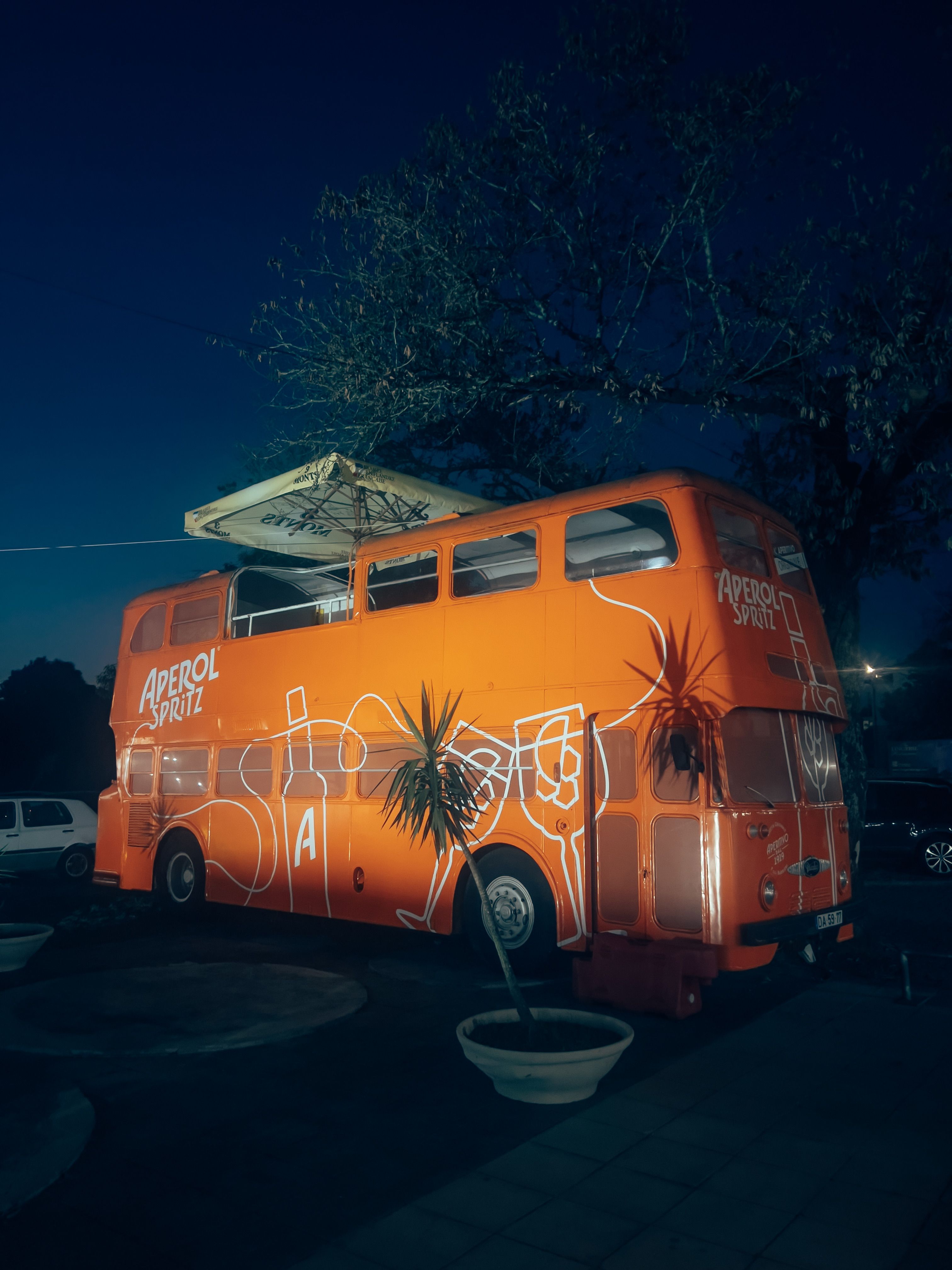 Vibrant Orange Double-Decker Bus at Night · Free Stock Photo