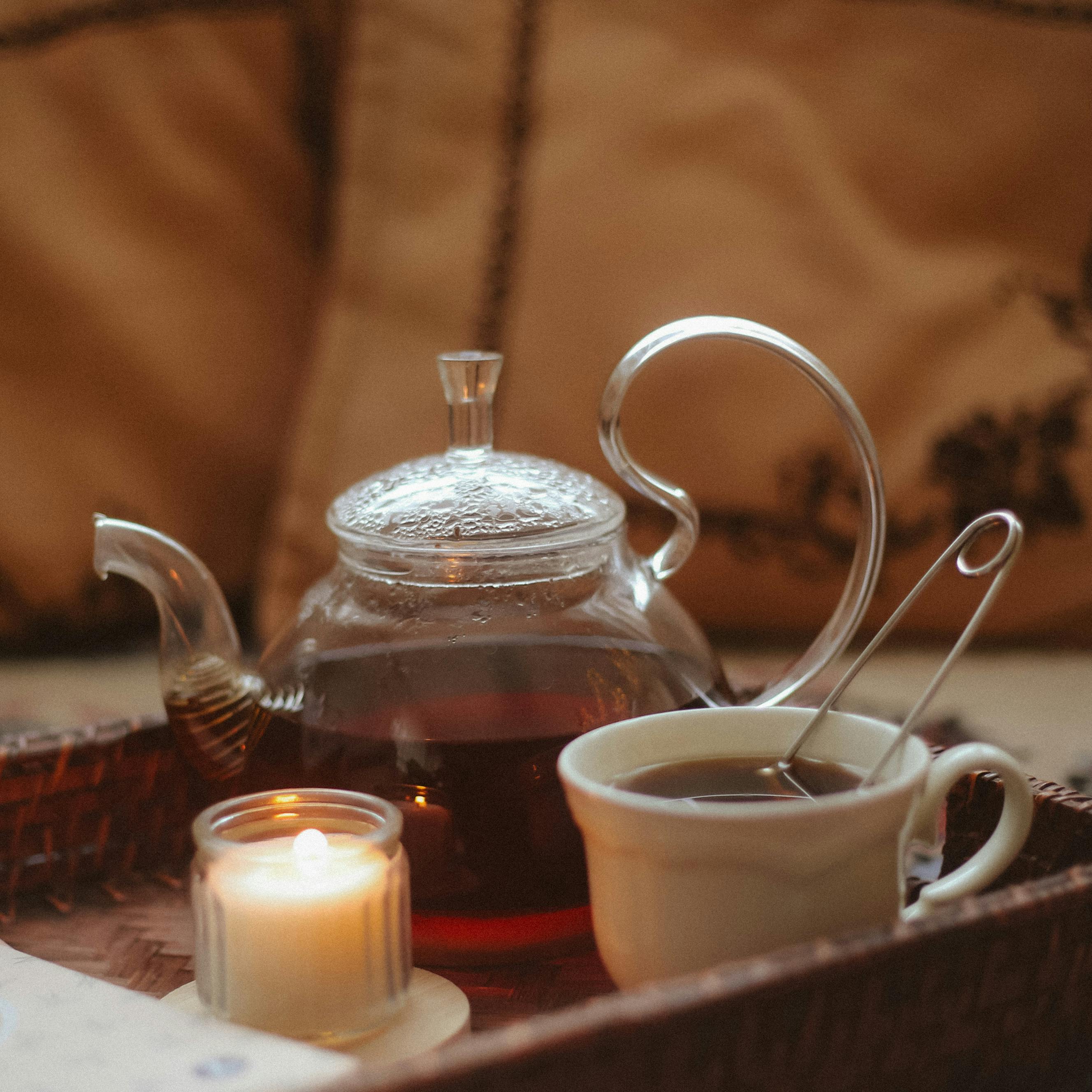 Cozy Tea Time with Candle and Book · Free Stock Photo