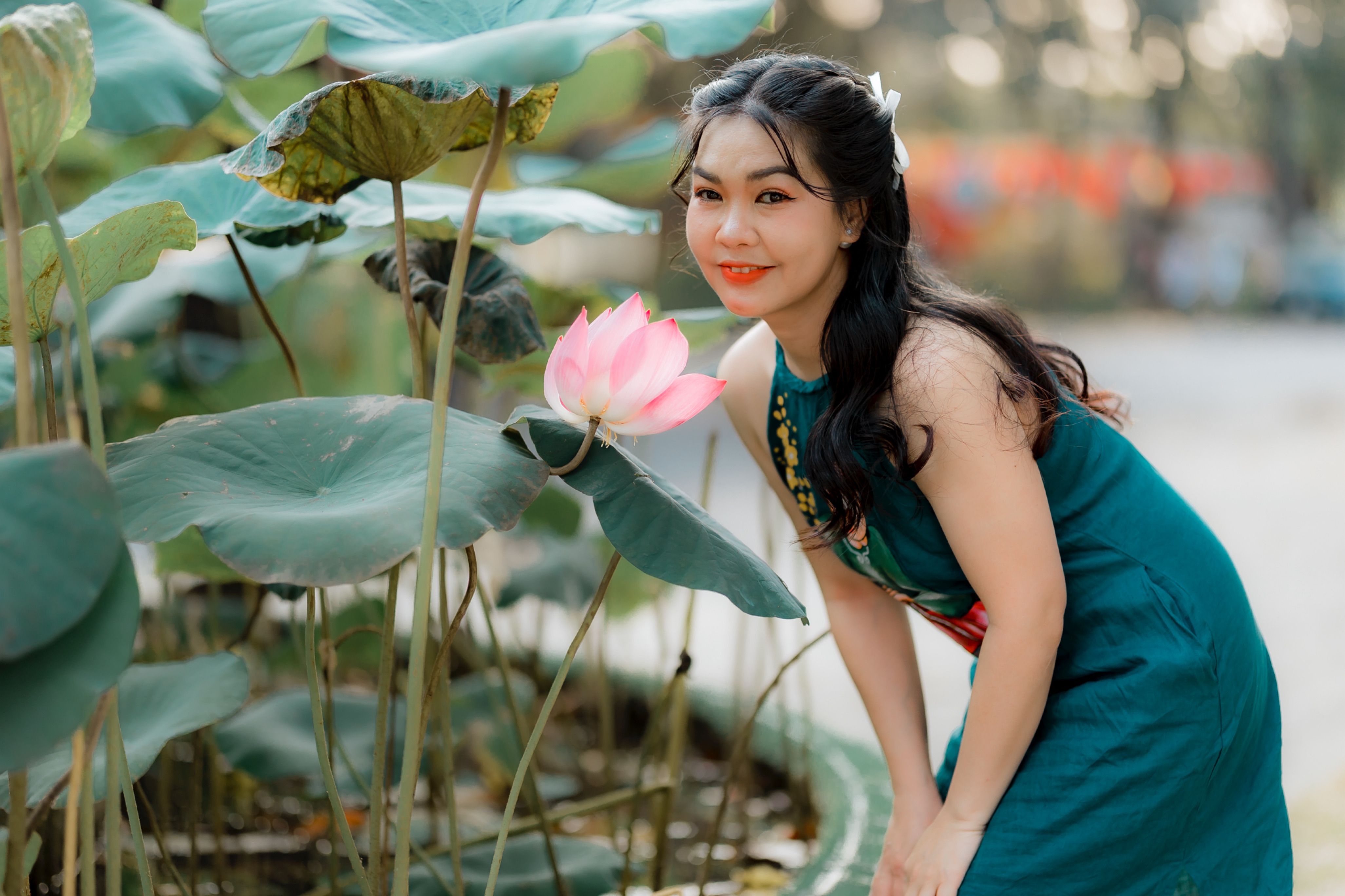 Woman Admiring Lotus Flower in Outdoor Garden · Free Stock Photo