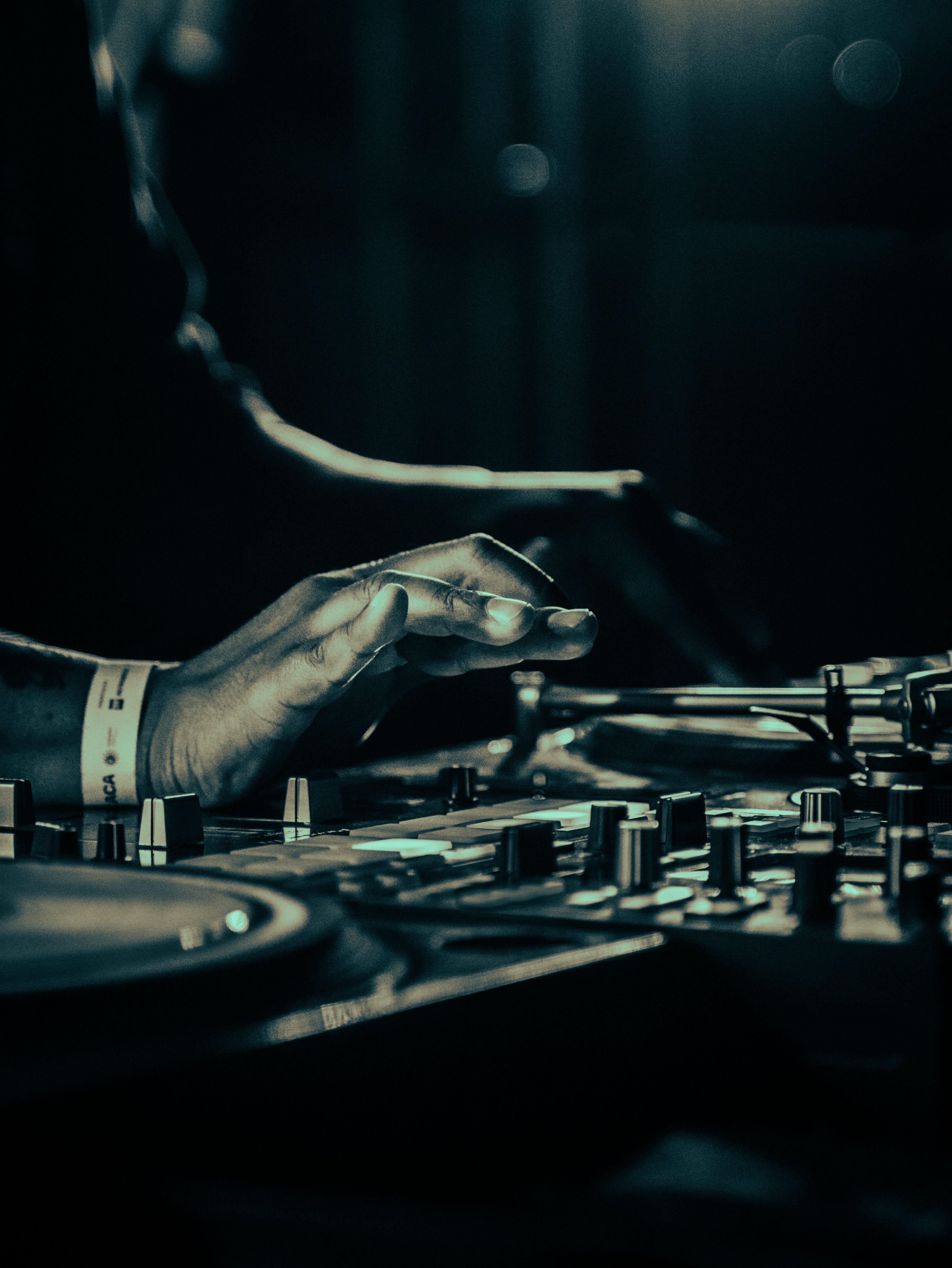 DJ Mixing Tracks on Turntable at Nightclub Event · Free Stock Photo