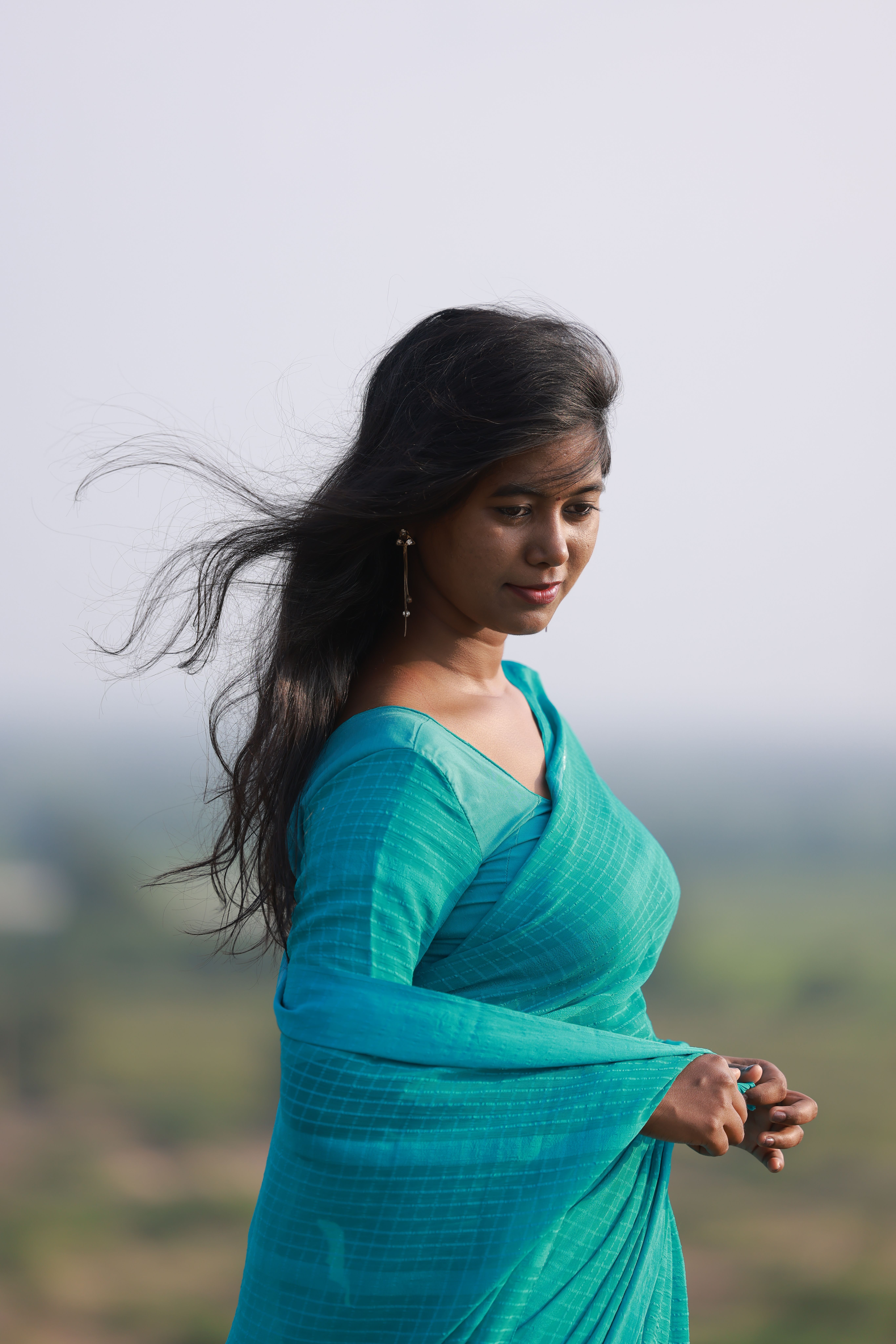 Portrait of Woman in Flowing Blue Saree Outdoors · Free Stock Photo