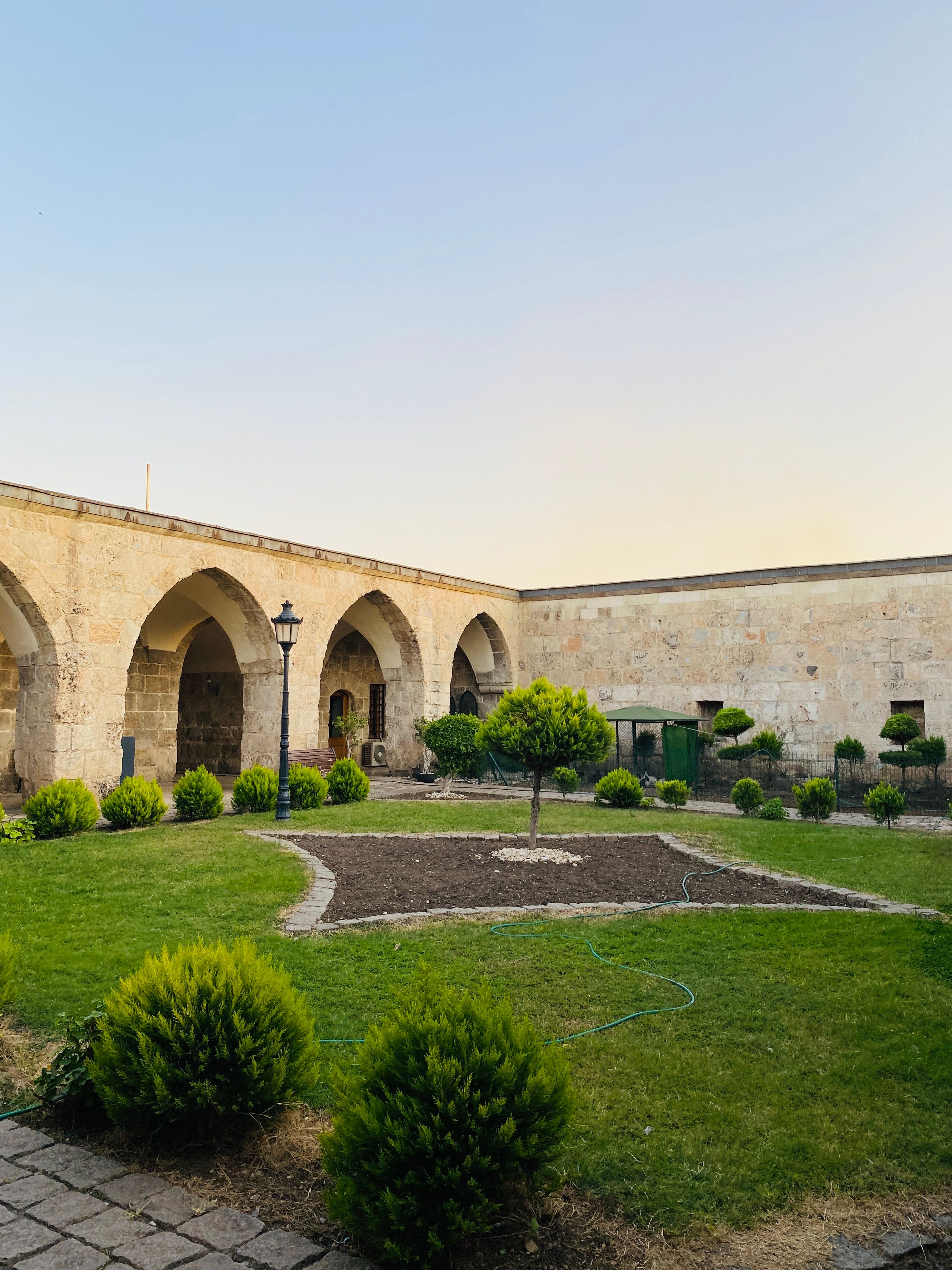 Historic Courtyard with Arched Stone Walls · Free Stock Photo