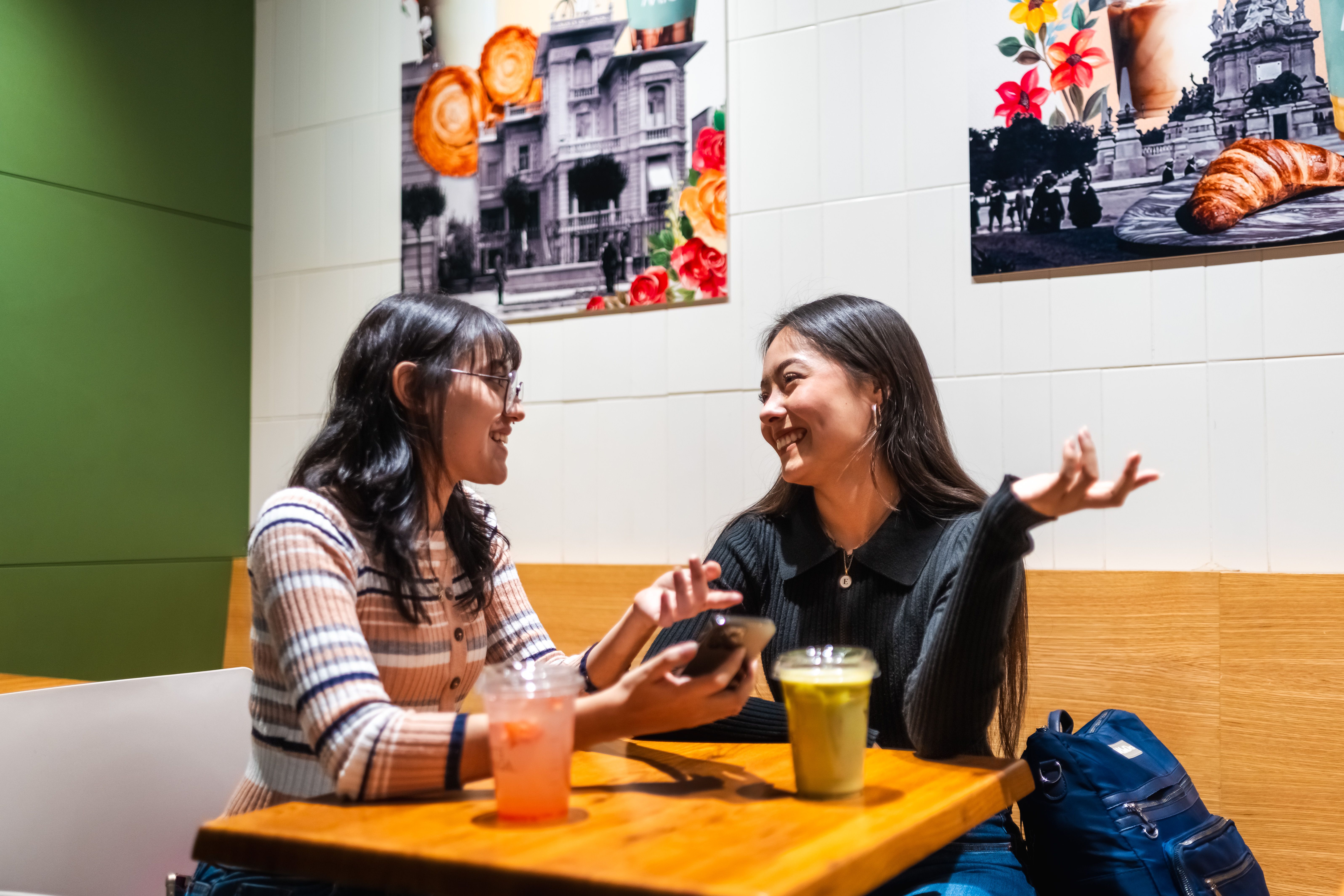Two Women Chatting Over Drinks in Café · Free Stock Photo